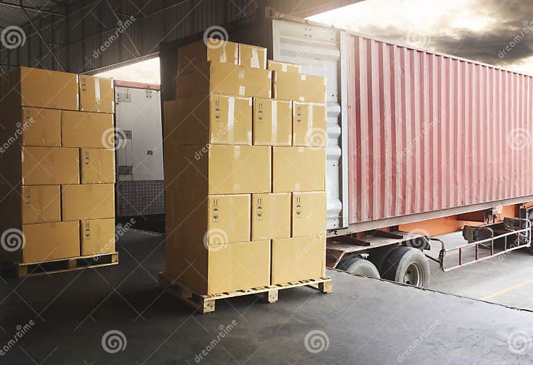 Stack of Package Boxes Load with Cargo Container. Trailer Truck Parked ...