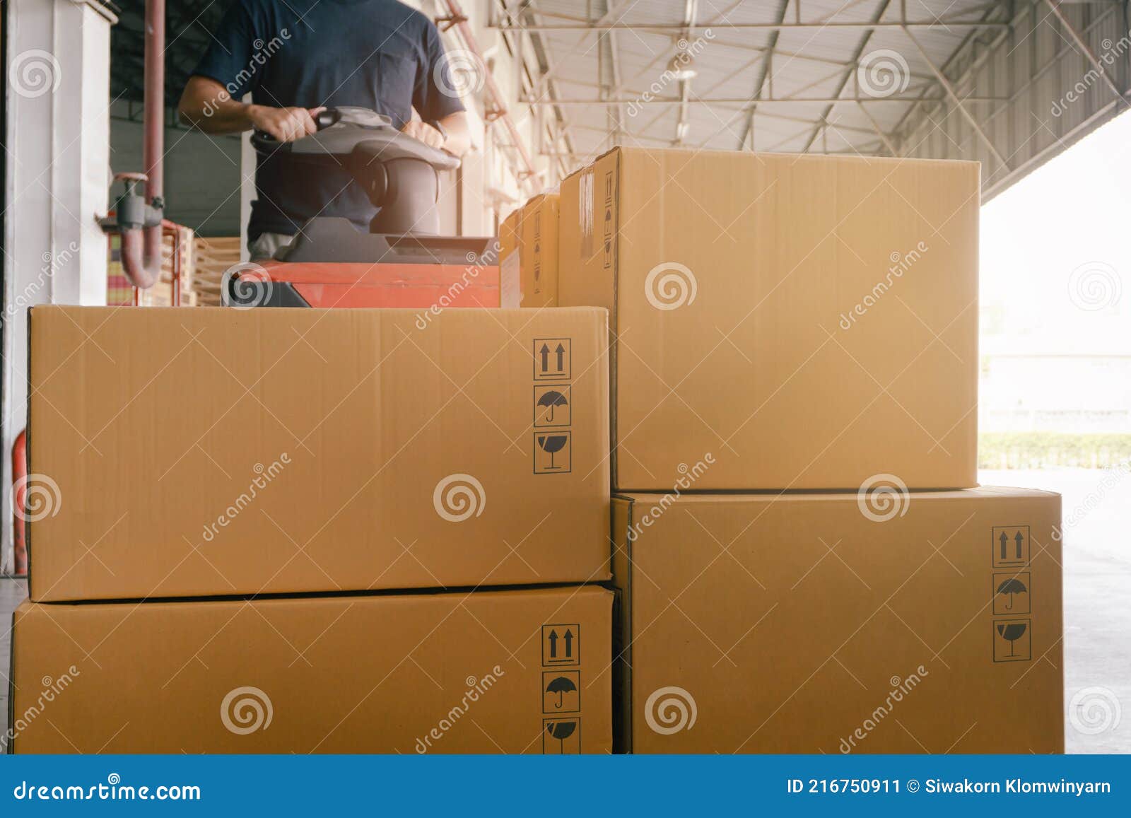 Stack of Package Boxes at the Warehouse. Woker Driving Forklift Pallet ...