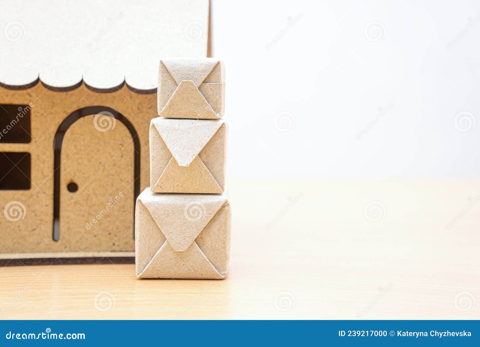 Stack of Packages by a House Model Isolated on White Stock Photo ...