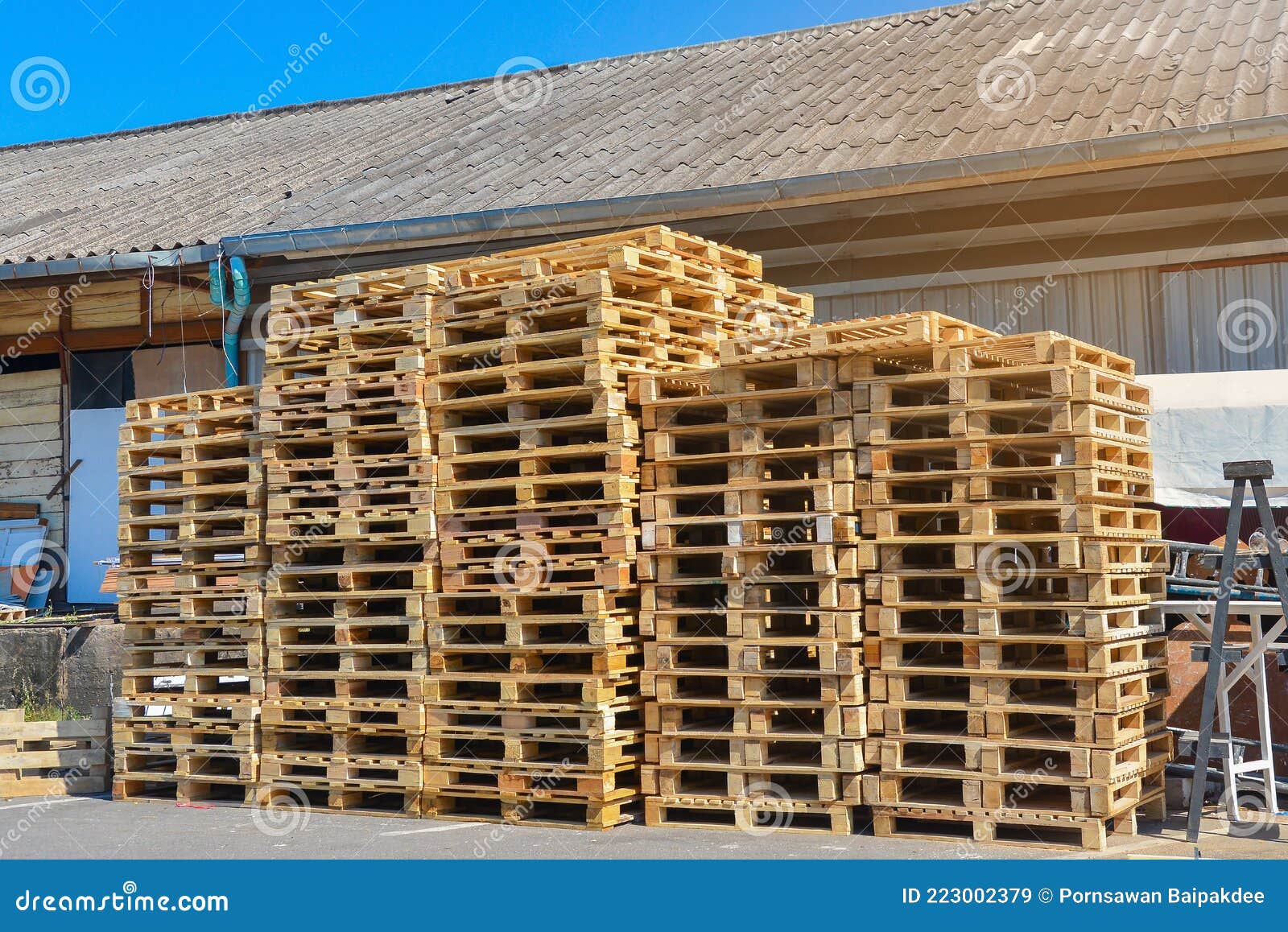 A Stack of Pallets Sit Outside a Building Stock Image - Image of ...