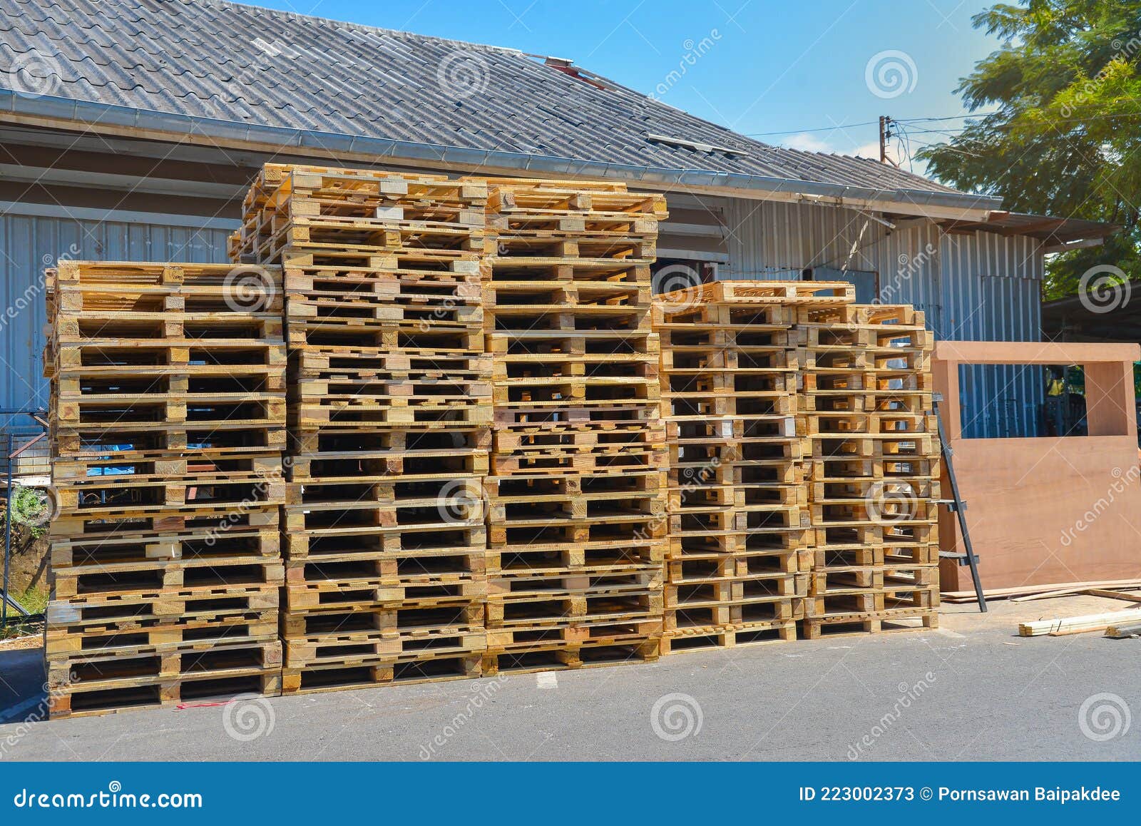 A Stack of Pallets Sit Outside a Building, Stock Image - Image of ...
