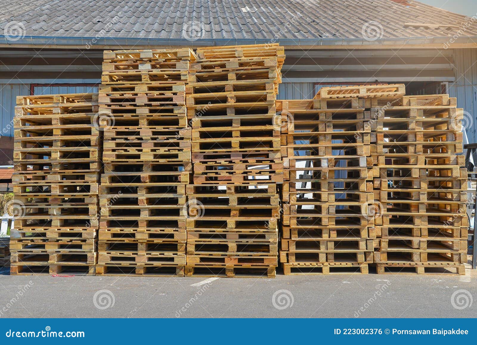 A Stack of Pallets Sit Outside a Building Stock Photo - Image of ...