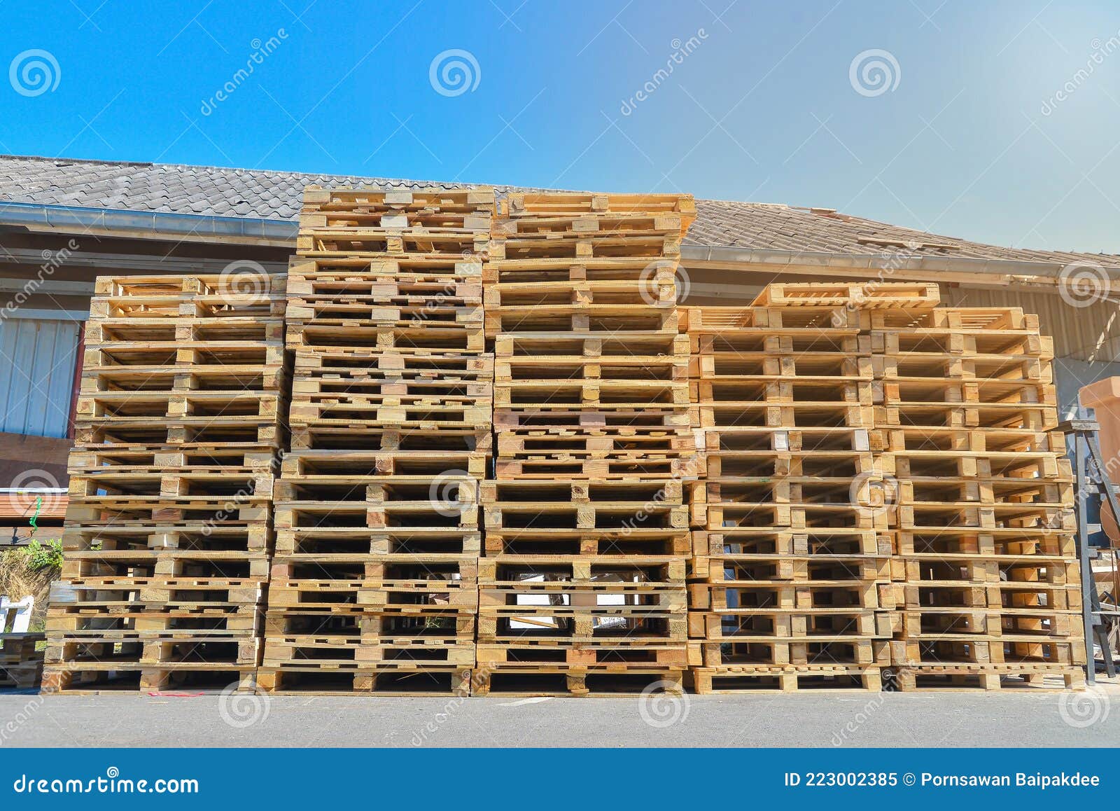 A Stack of Pallets Sit Outside a Building Stock Image - Image of ...