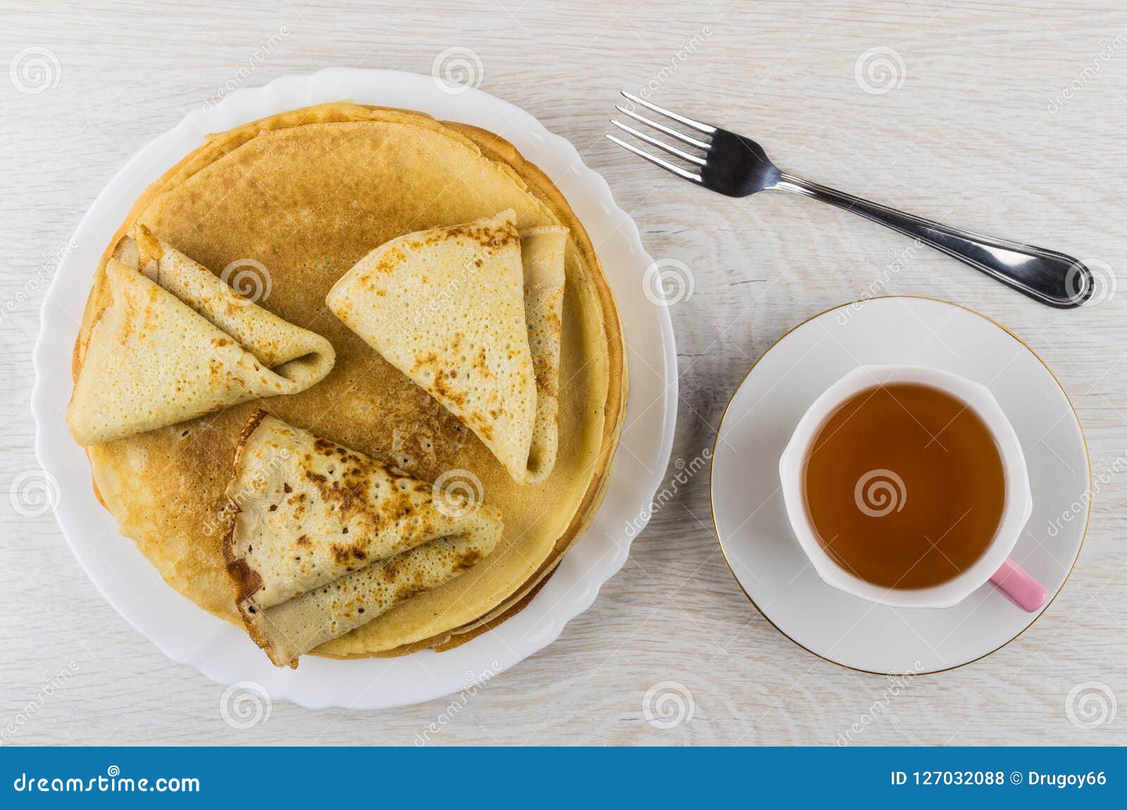 Stack of Pancakes, Folded Pancakes, Tea on Saucer, Fork Stock Photo ...