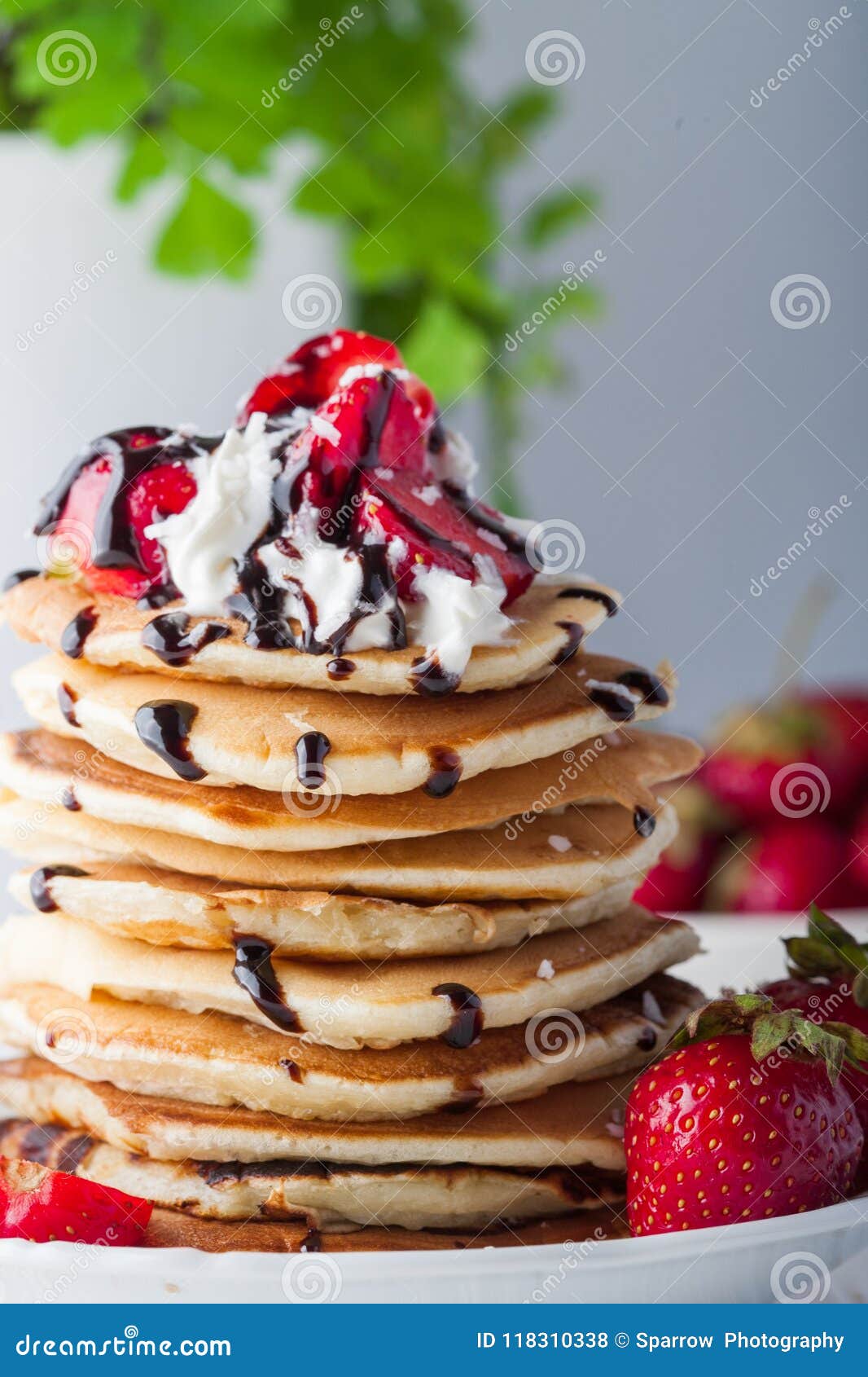 Stack of Pancakes with Strawberries, Whip Cream and Chocolate Syrup on ...