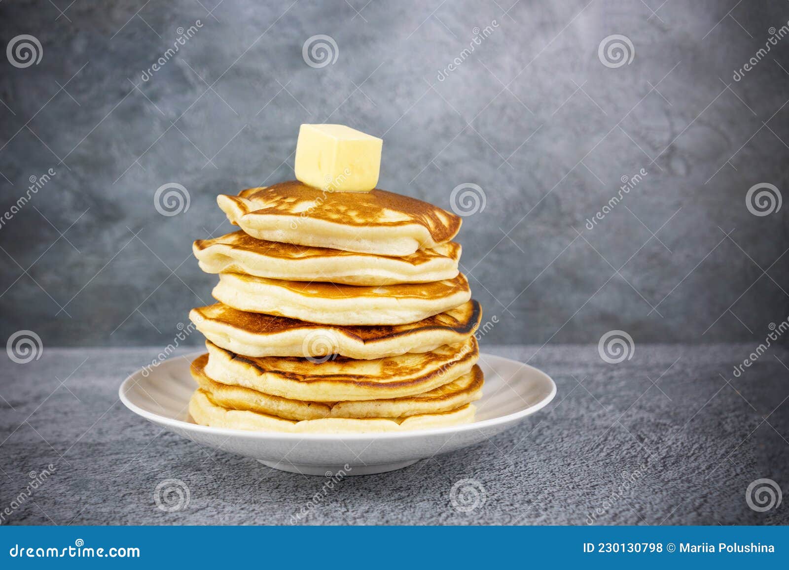 Stack of Pancakes on White Plate with Piece of Butter on Top, on Gray ...