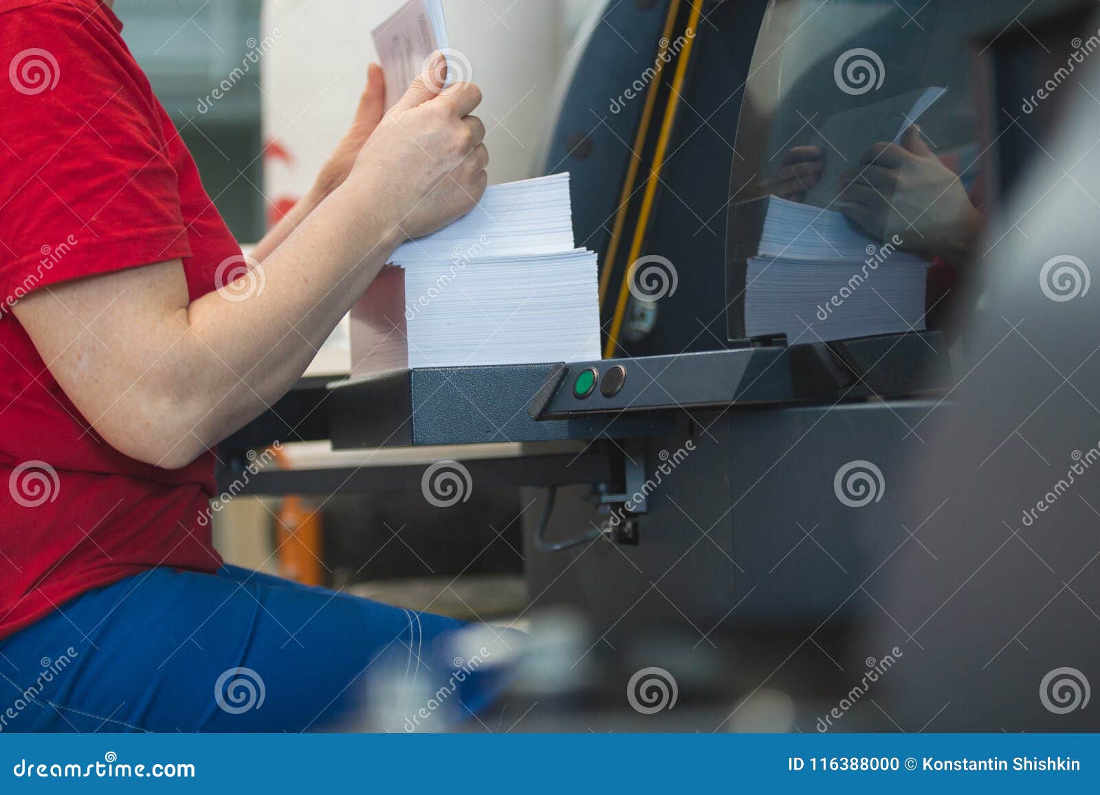 Stack of Paper in Hands of Female Worker in Front of Printing Press ...