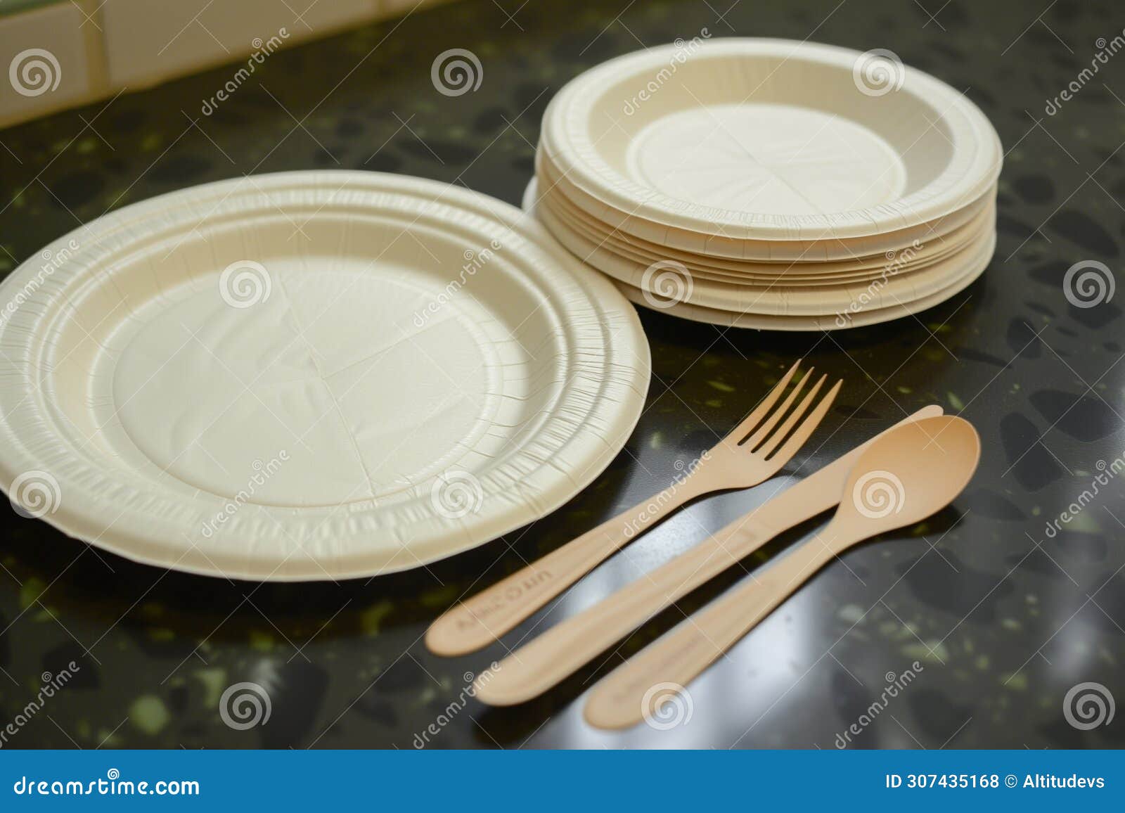 Stack of Paper Plates beside Disposable Cutlery on a Table Stock Photo ...