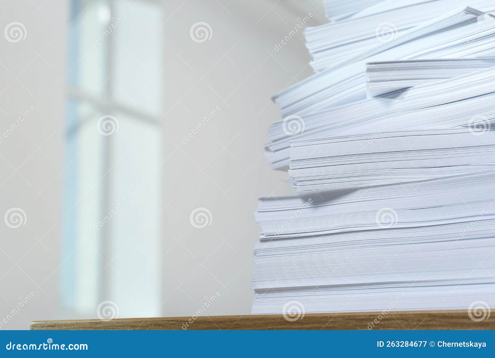 Stack of Paper Sheets on Wooden Table Against Blurred Background ...