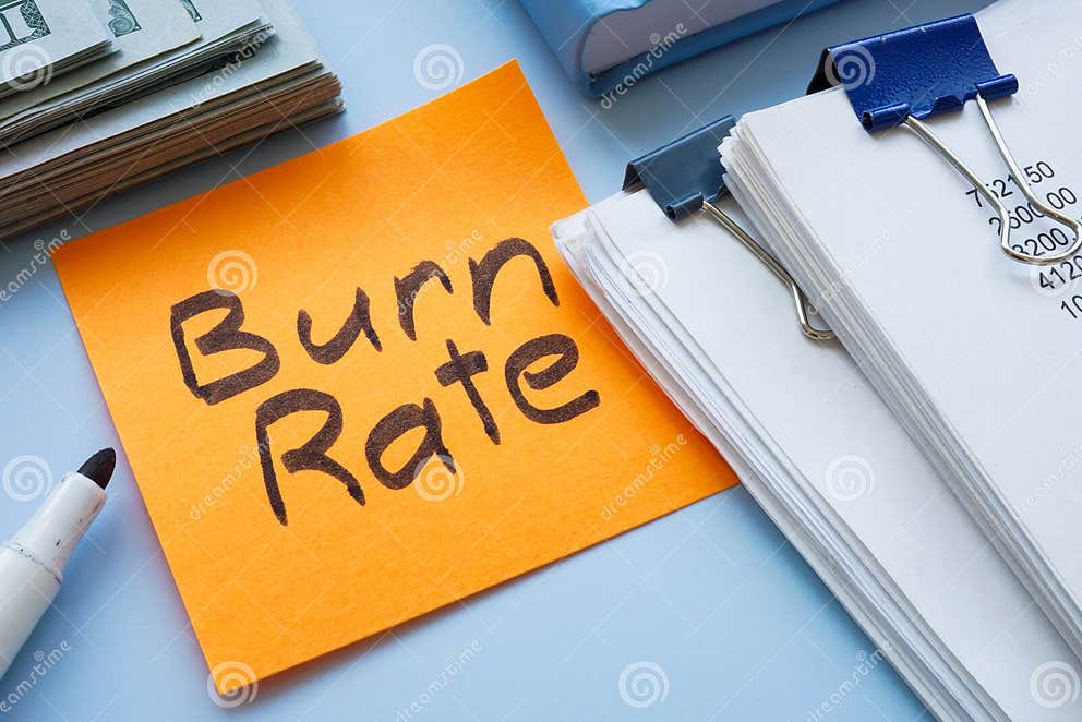 Stack of Papers, Cash, and a Sticky Note with Burn Rate. Cash Flow ...