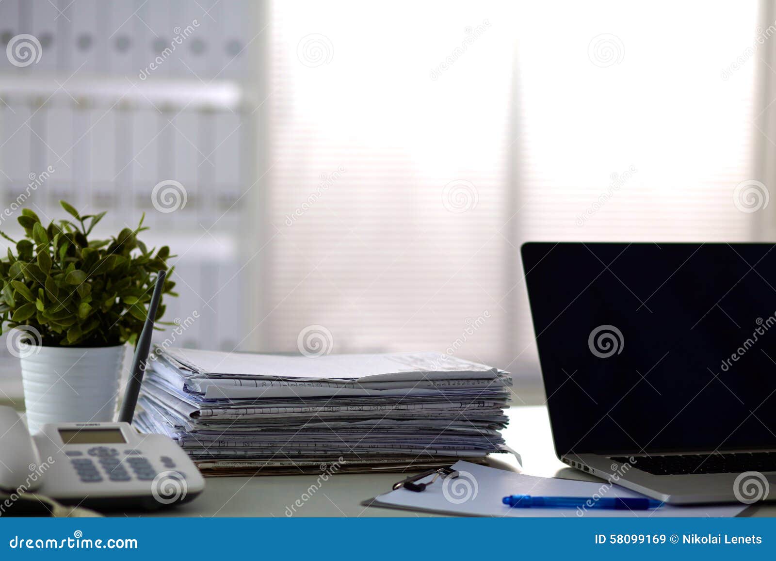 A Stack of Papers on the Desk with a Computer Stock Image - Image of ...