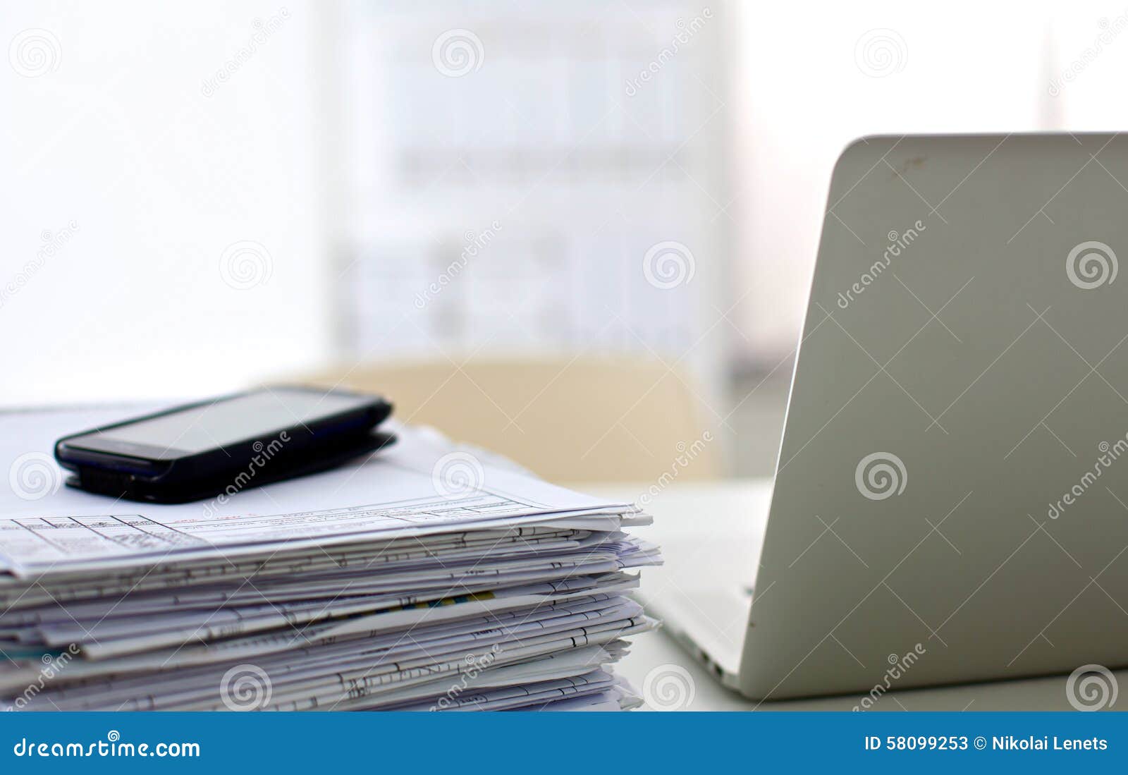 A Stack of Papers on the Desk with a Computer Stock Image - Image of ...