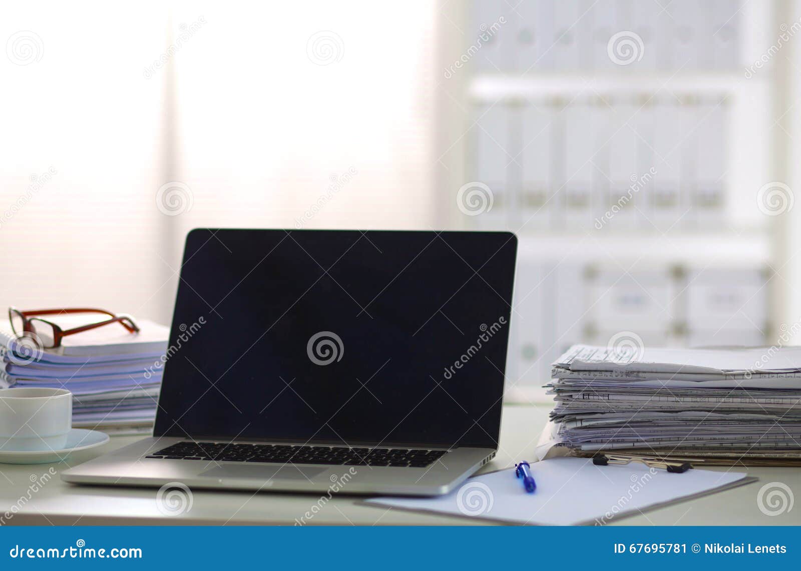 A Stack of Papers on the Desk with a Computer Stock Image - Image of ...