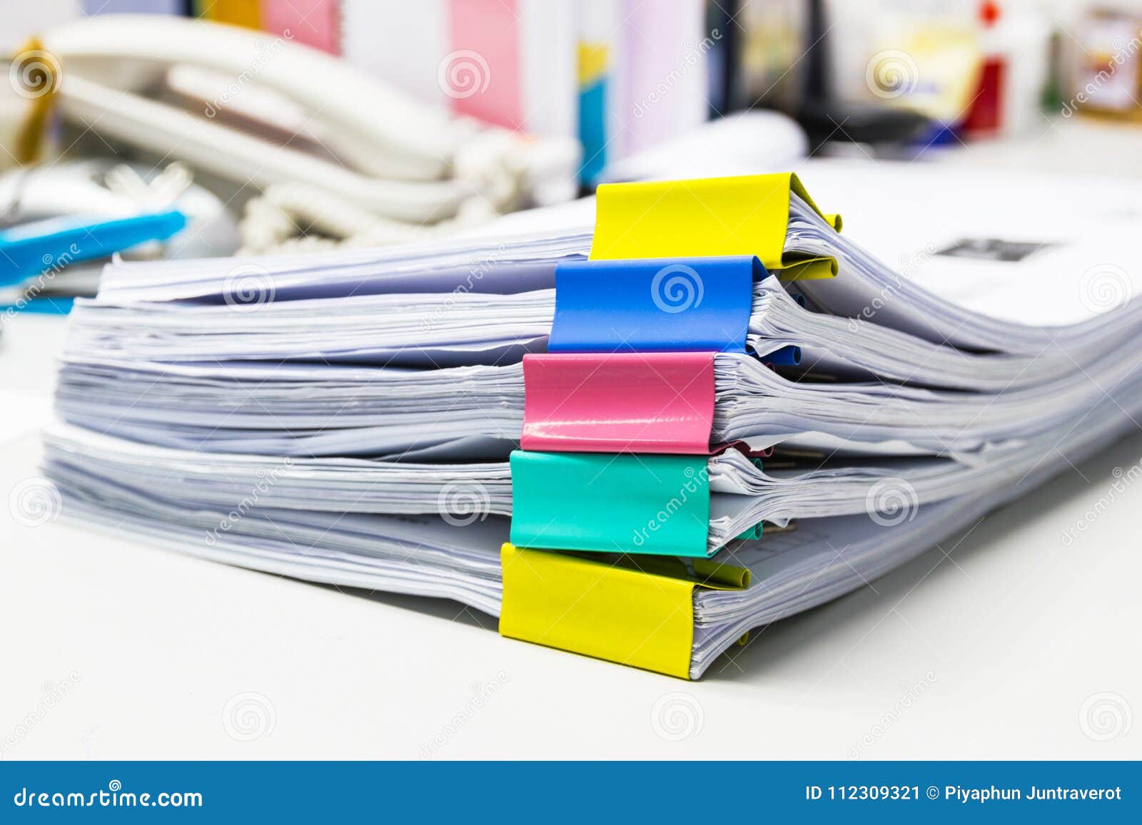 Stack of Papers Documents in Archives Files with Paper Clips on Desk at ...