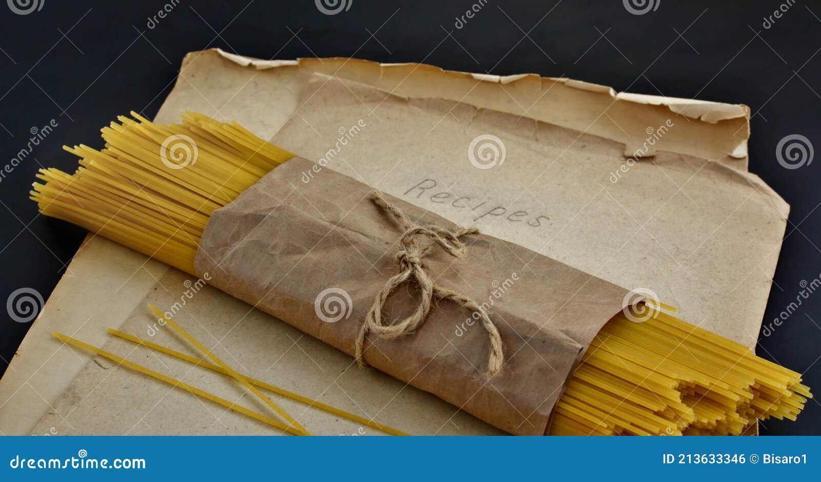 A Stack of Pasta Wrapped in Kraft Paper on a Table with Aged Sheets of ...