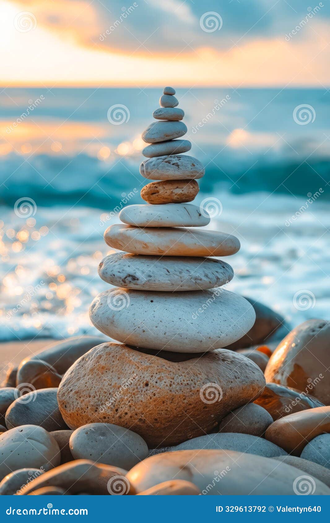 A Stack of Pebbles on a Beach with the Ocean in the Background ...
