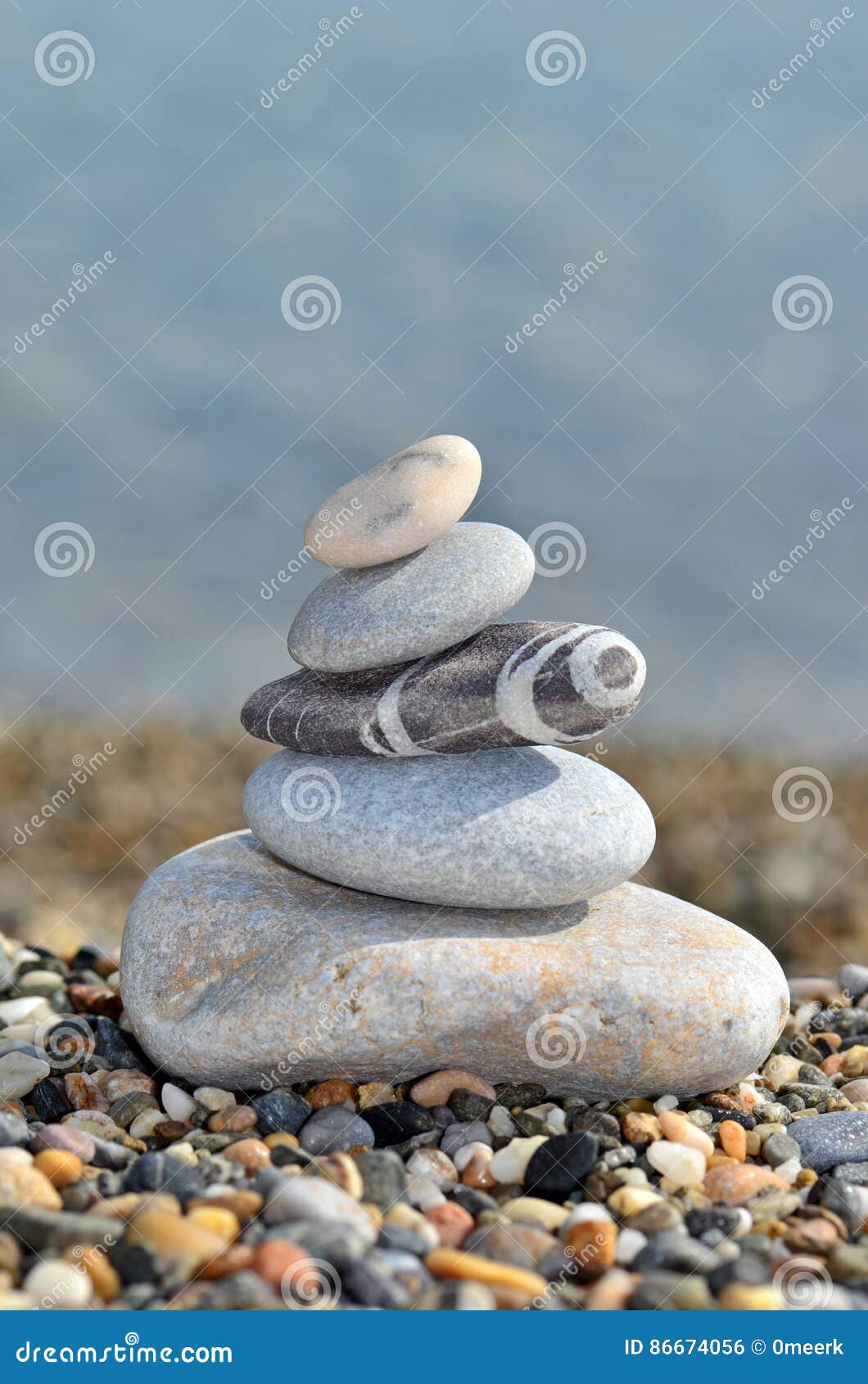 Stack of pebbles on beach stock photo. Image of blue - 86674056