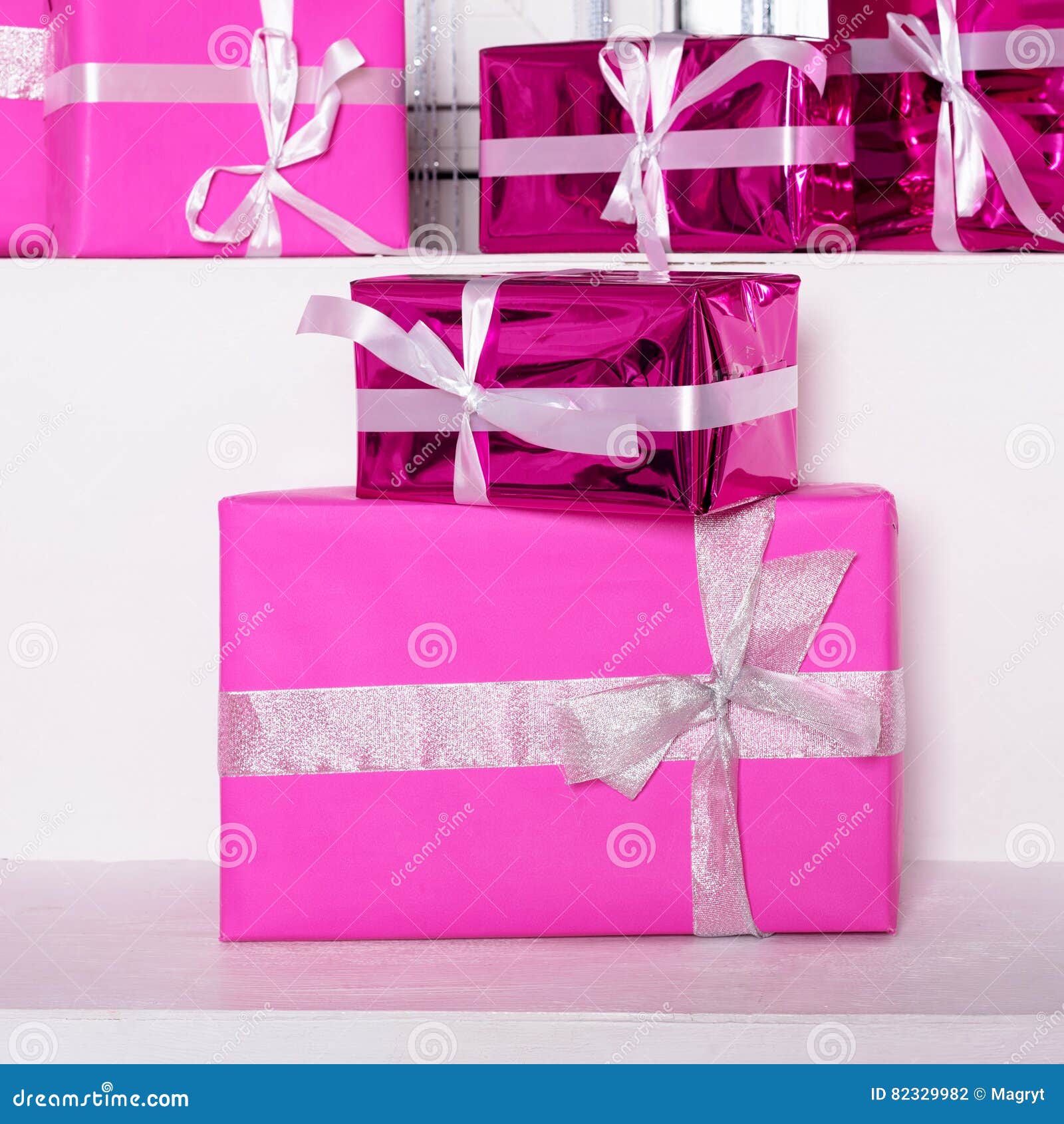 Stack of Pink Celebration Gift Boxes with Ribbon Bows on White Table ...