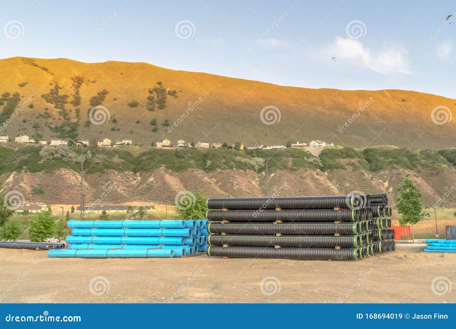 Stack of Pipes at a Construction Area with Mountain and Sky in the ...