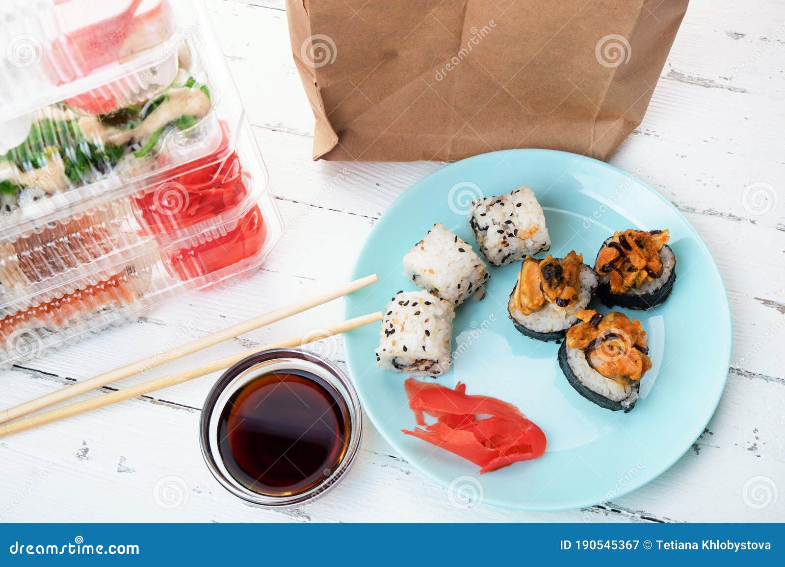 Stack of Plastic Boxes with Sushi Roll Sets, Plate with Rolls and Paper ...