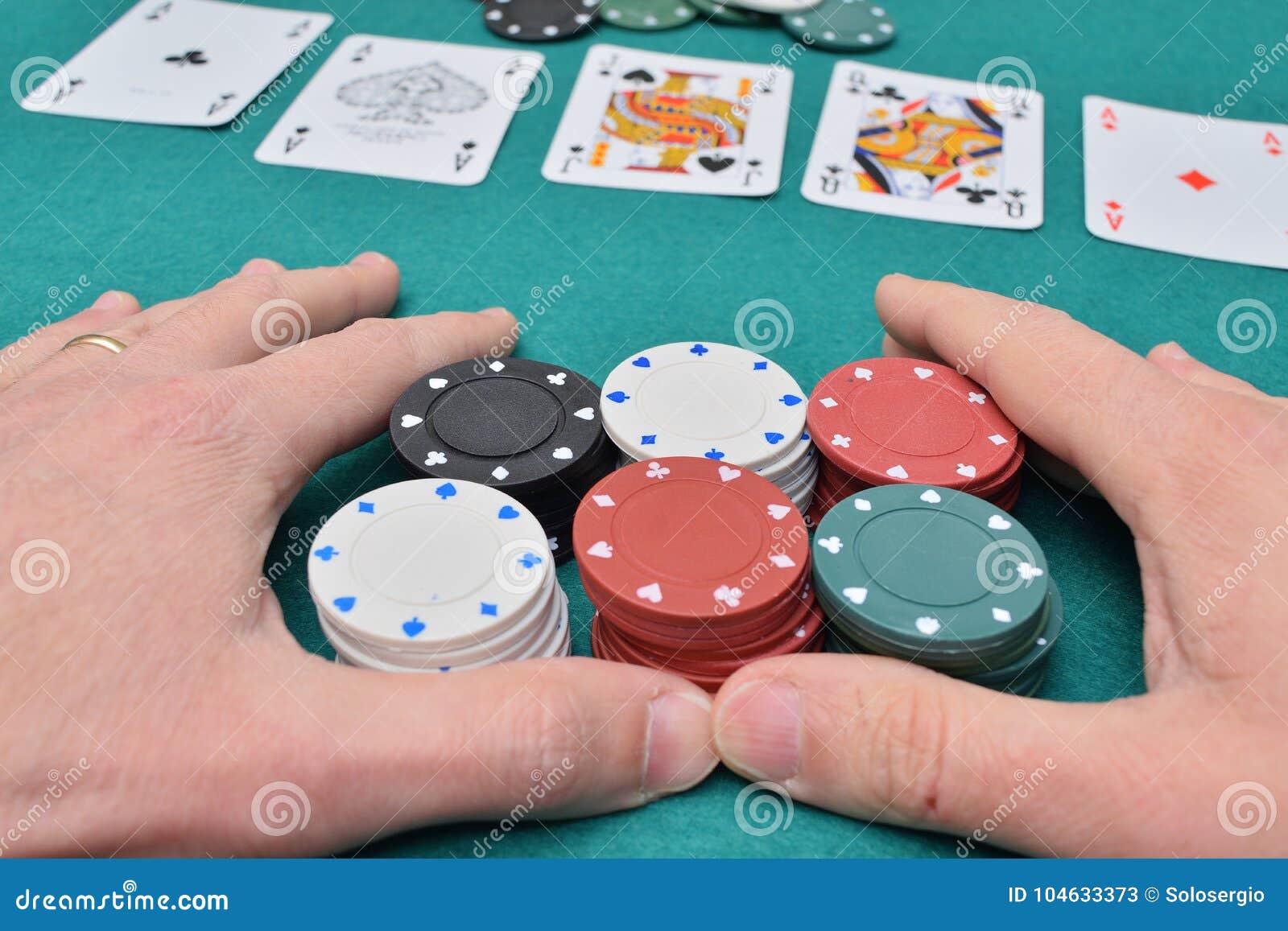 Stack of Poker Chips in Two Hands and Cards on a Gambling Table Stock ...