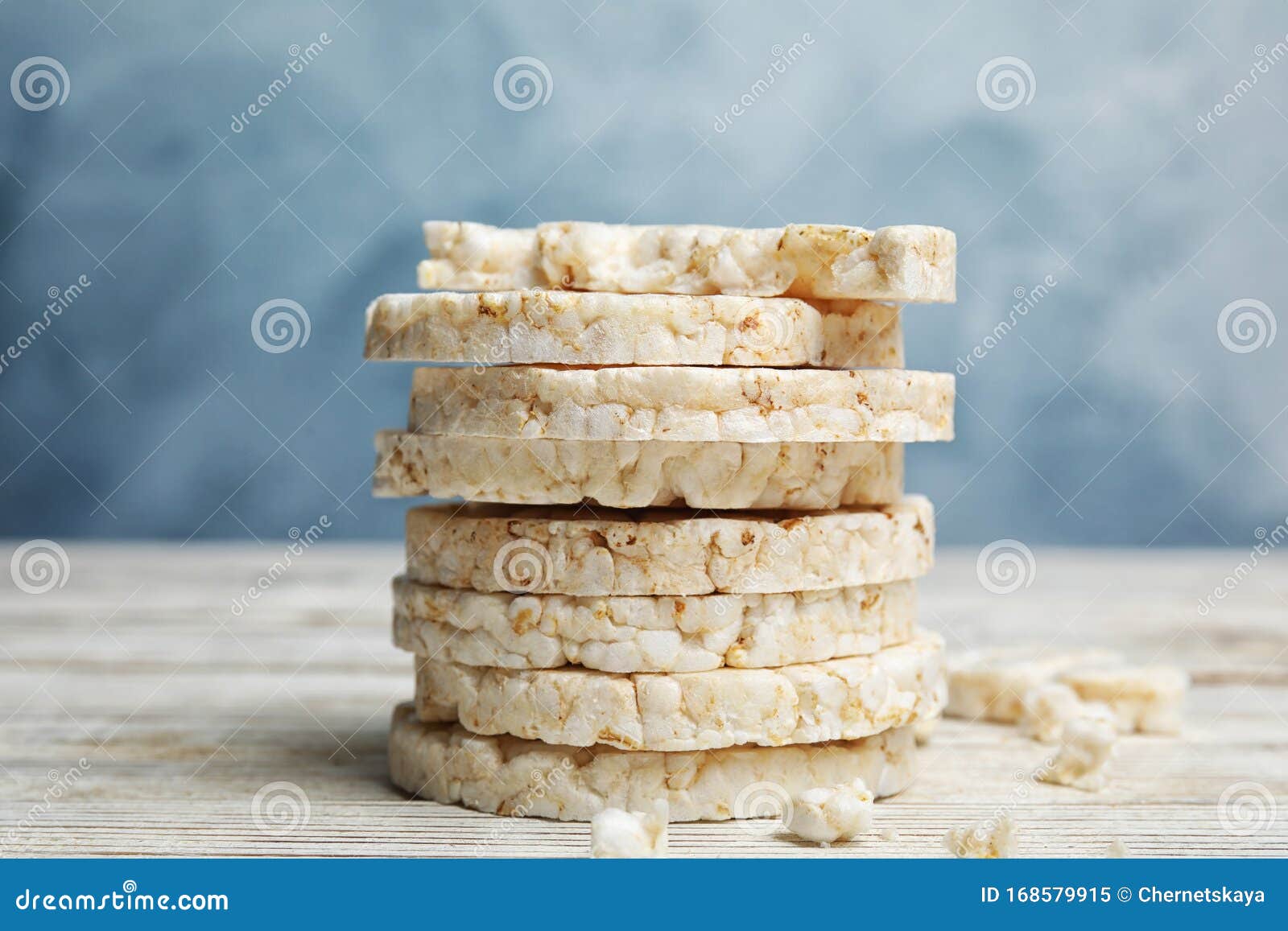 Stack Of Puffed Rice Cakes On White Table Against Light Blue Background ...