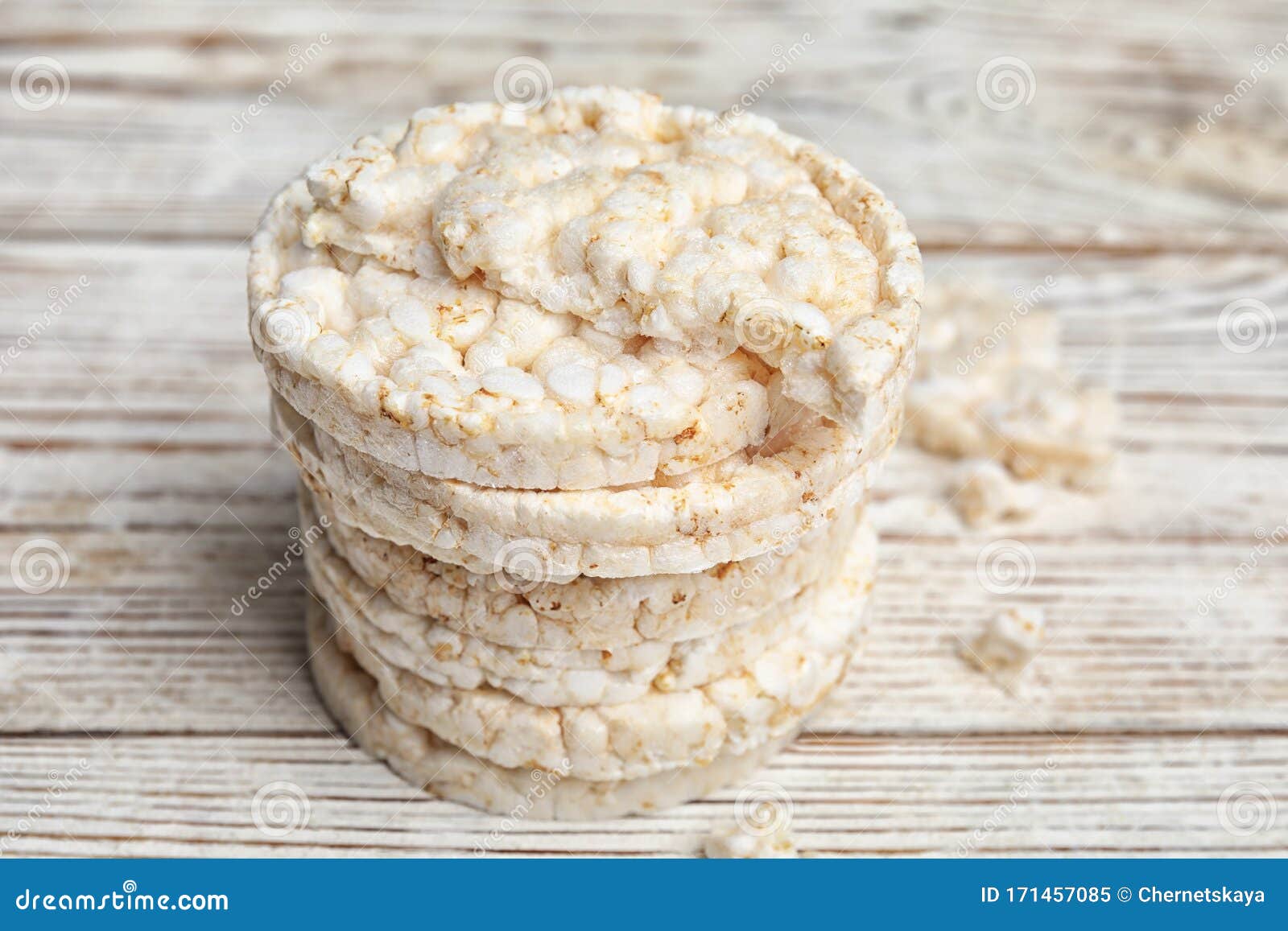 Stack Of Puffed Rice Cakes On White Table Against Light Blue Background ...