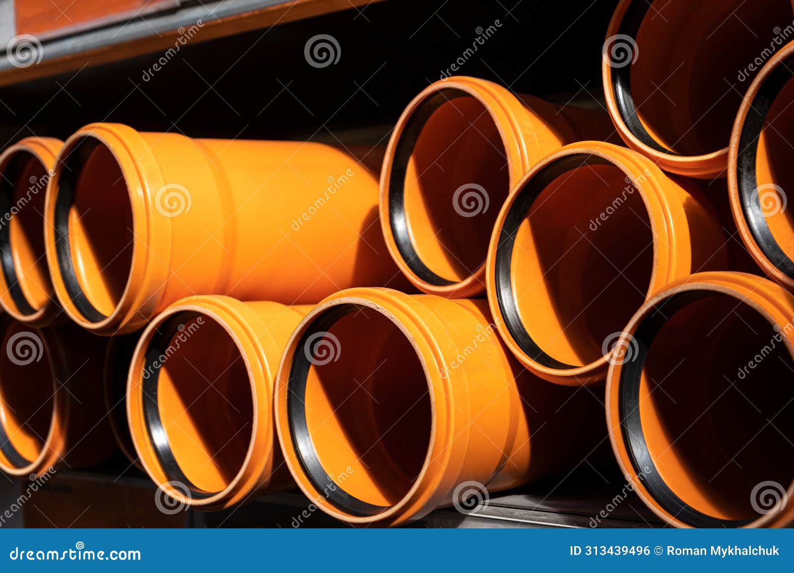 Stack of PVC U Canalization Pipes on a Store. Brown Plastic Pipes ...