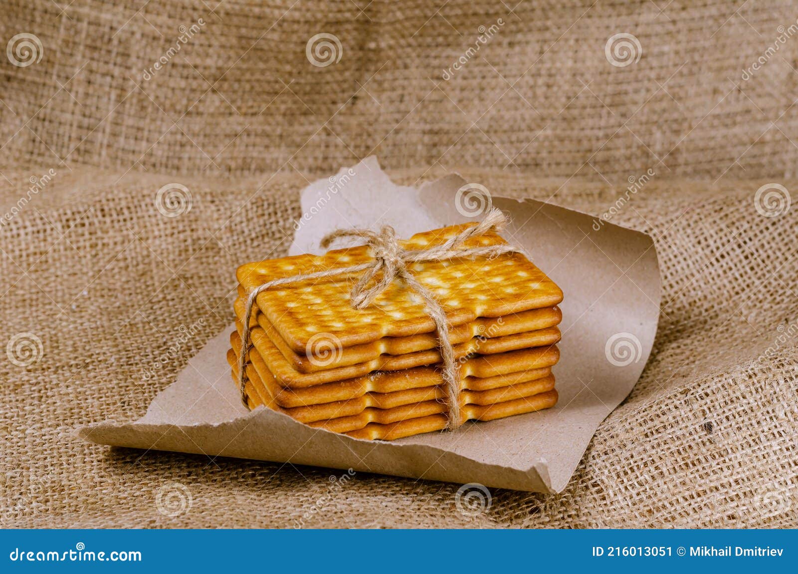 A Stack of Rectangular Crackers Tied with String on Sackcloth Stock ...