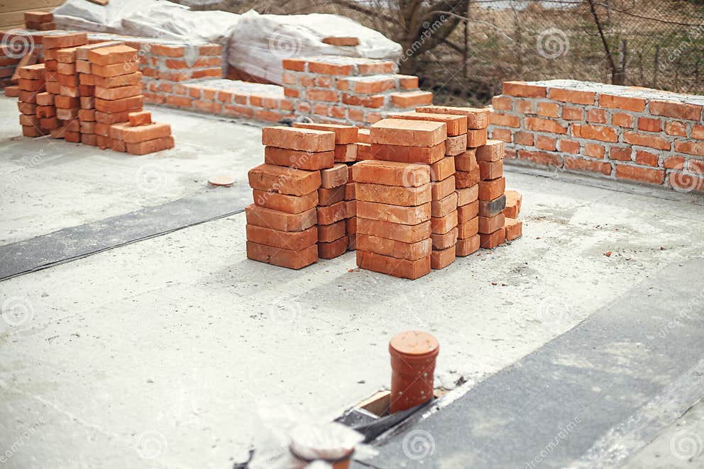 Stack of Red Bricks on Concrete Foundation, Process of House Building ...
