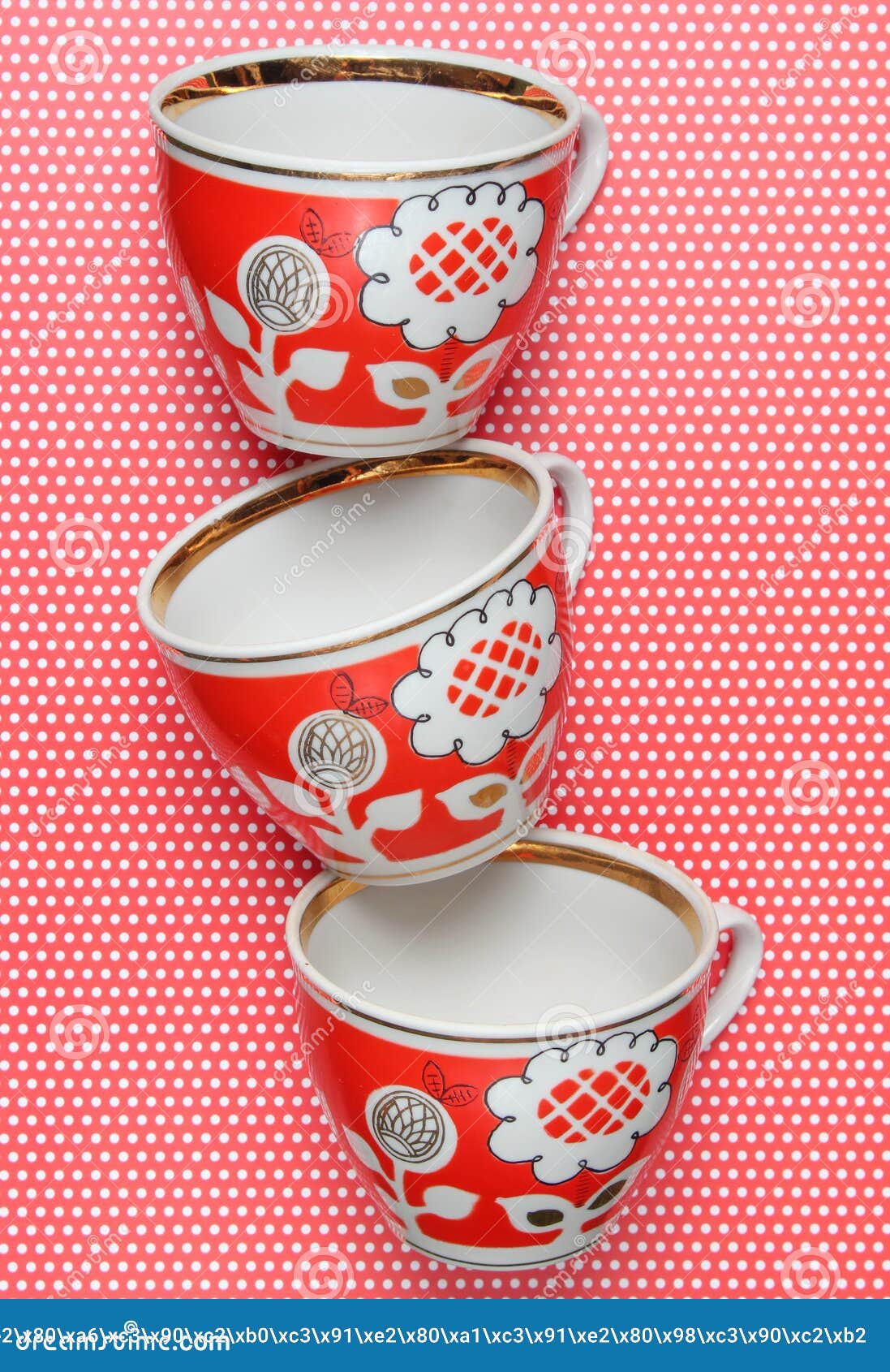 Stack of Retro Cups with Red Patterns on a Tablecloth Whith Polka Dots ...