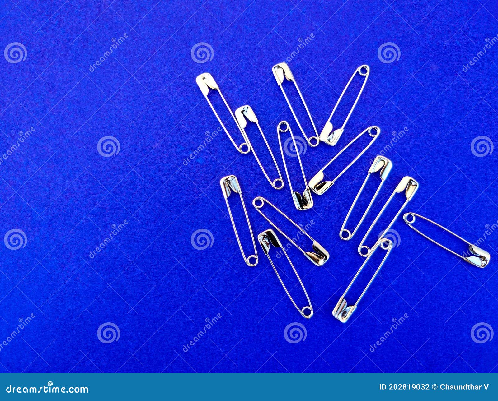 Stack of Safety Pins on Blue Background. Stock Photo - Image of collect ...