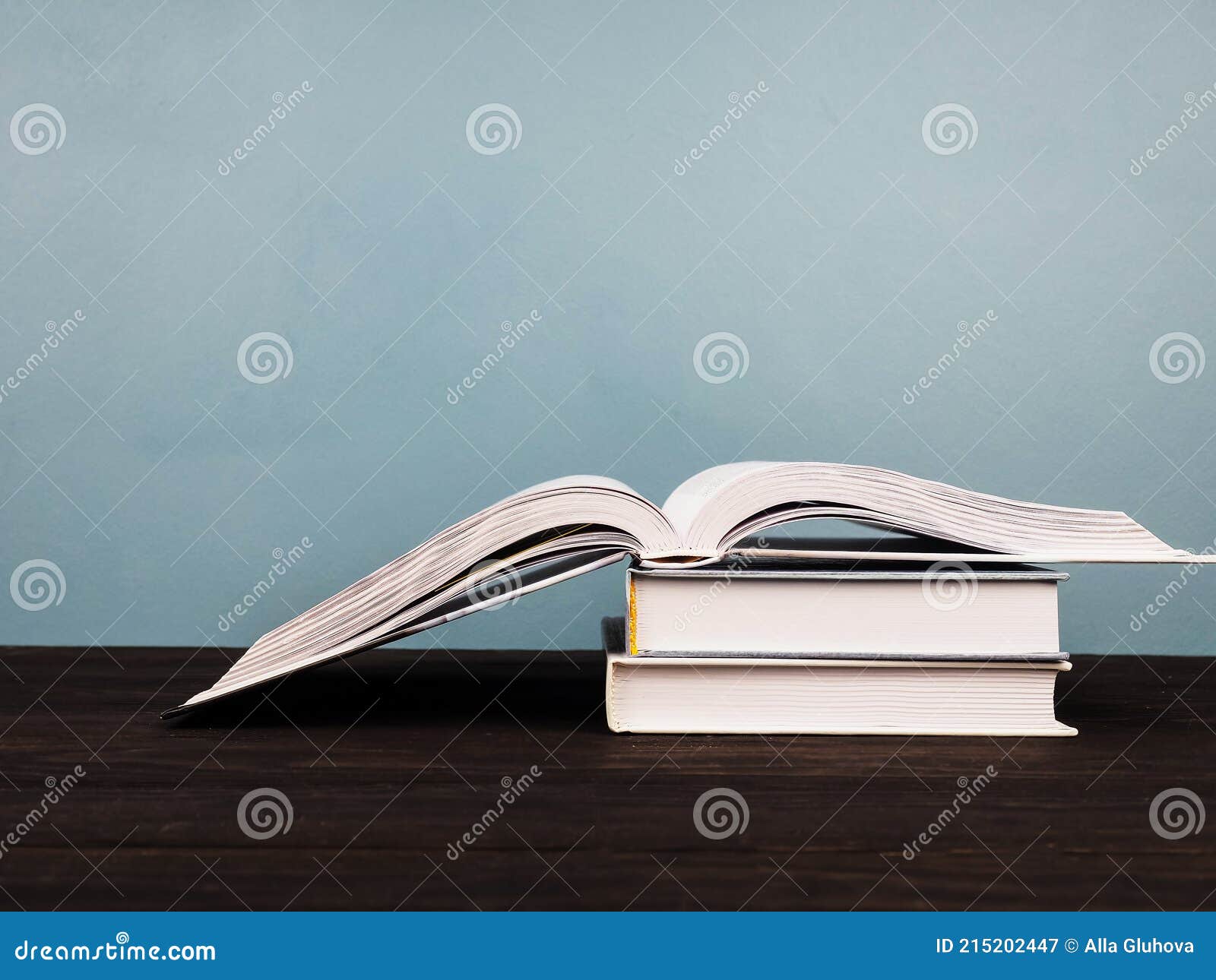 A Stack of Several Books, Close-up, Open Book in the Foreground Stock ...