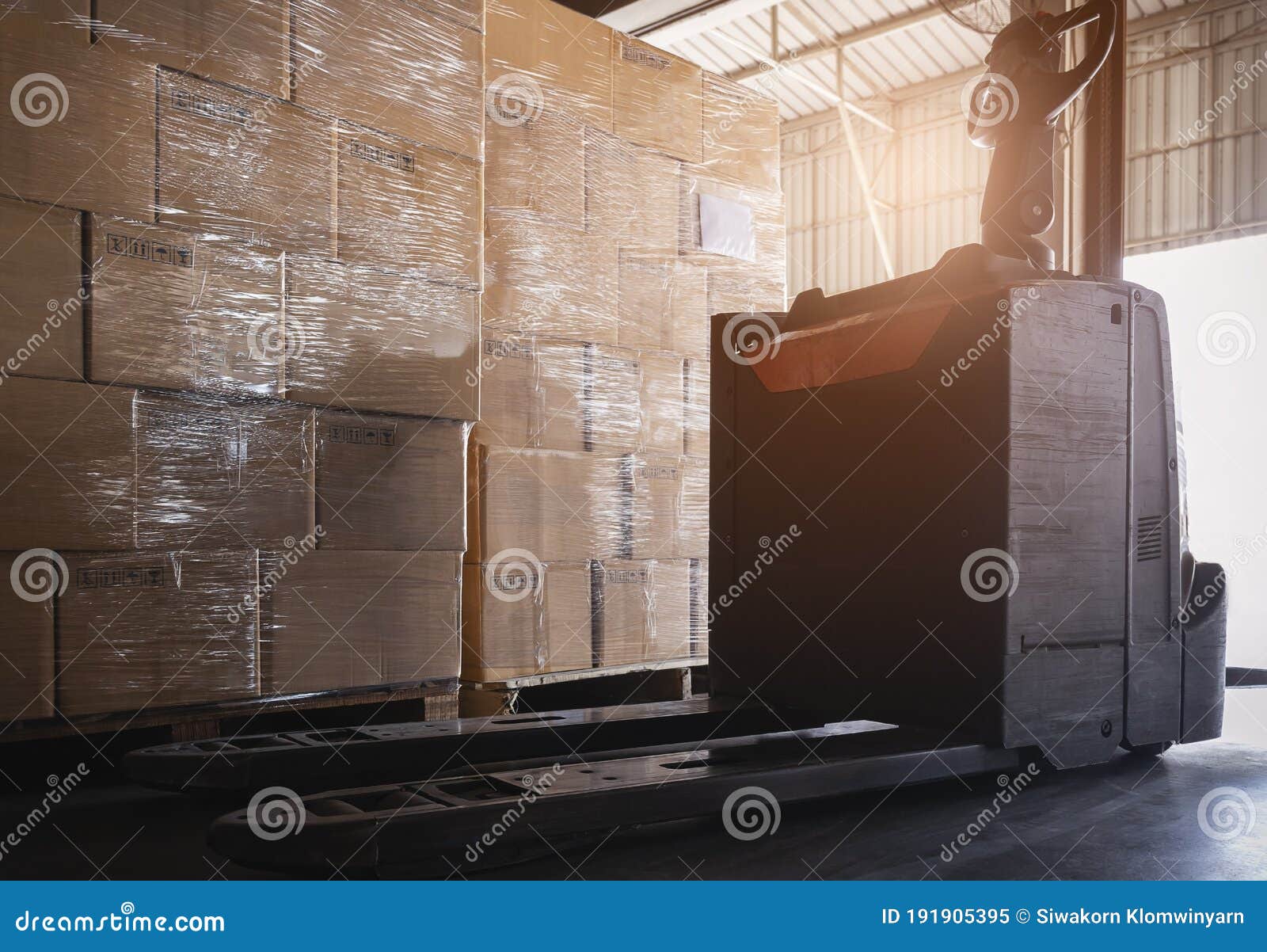 Stack of Shipment Cardboard Boxes with Electric Forklift Pallet Jack at ...