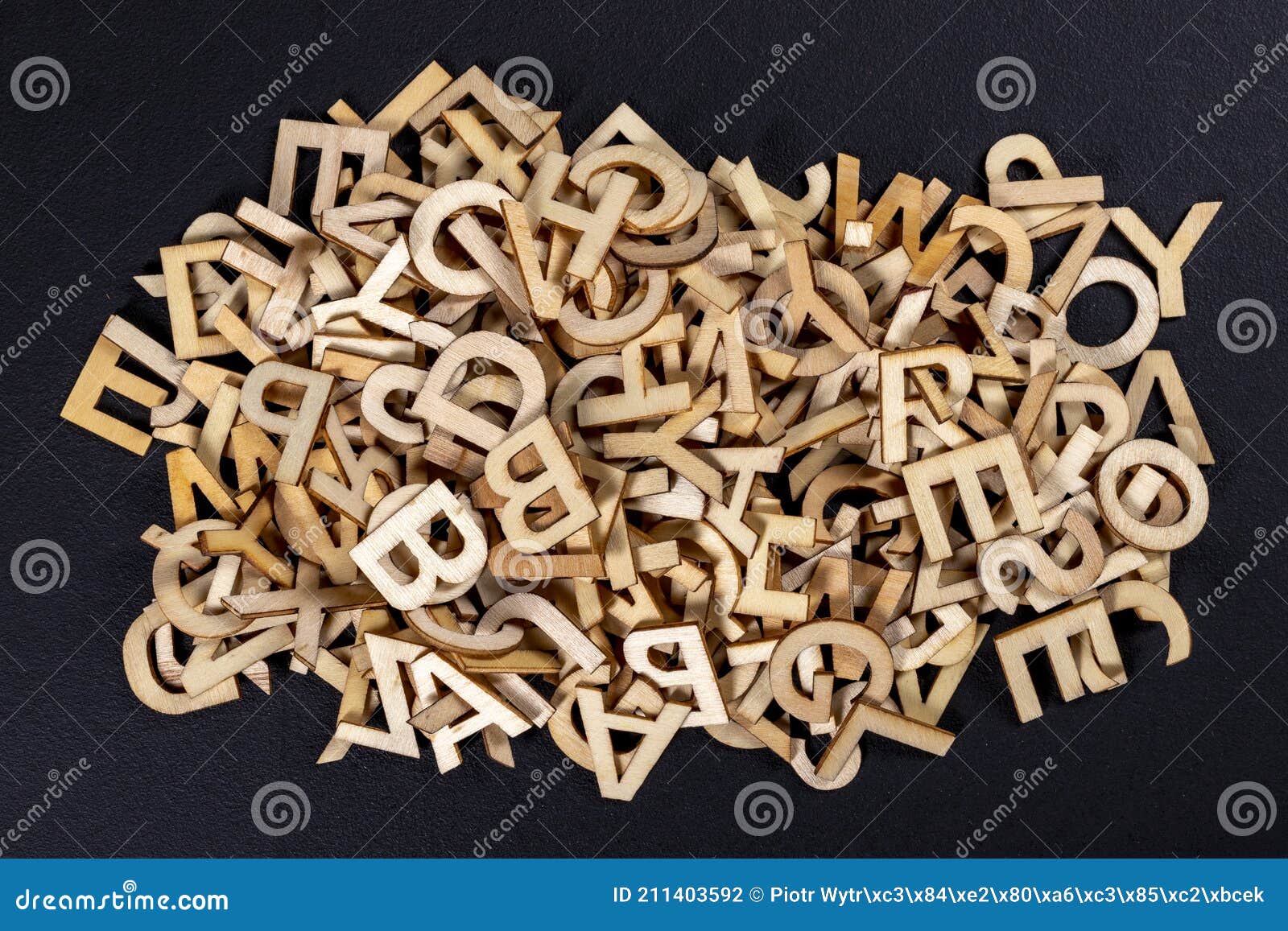 A Stack of Small Wooden Letters on a Dark Table. Letters Outlines for ...
