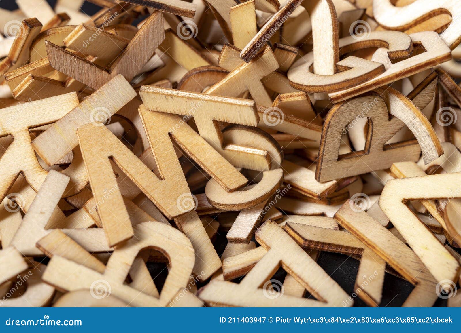 A Stack of Small Wooden Letters on a Dark Table. Letters Outlines for ...