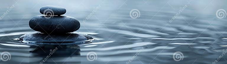 A Stack of Smooth, Gray Rocks Sit on a Calm, Misty Water Stock ...