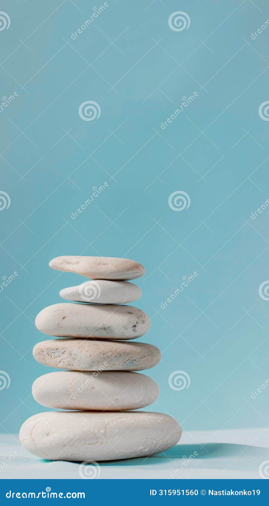 Stack of Smooth White Stones on a Blue Background Stock Photo - Image ...
