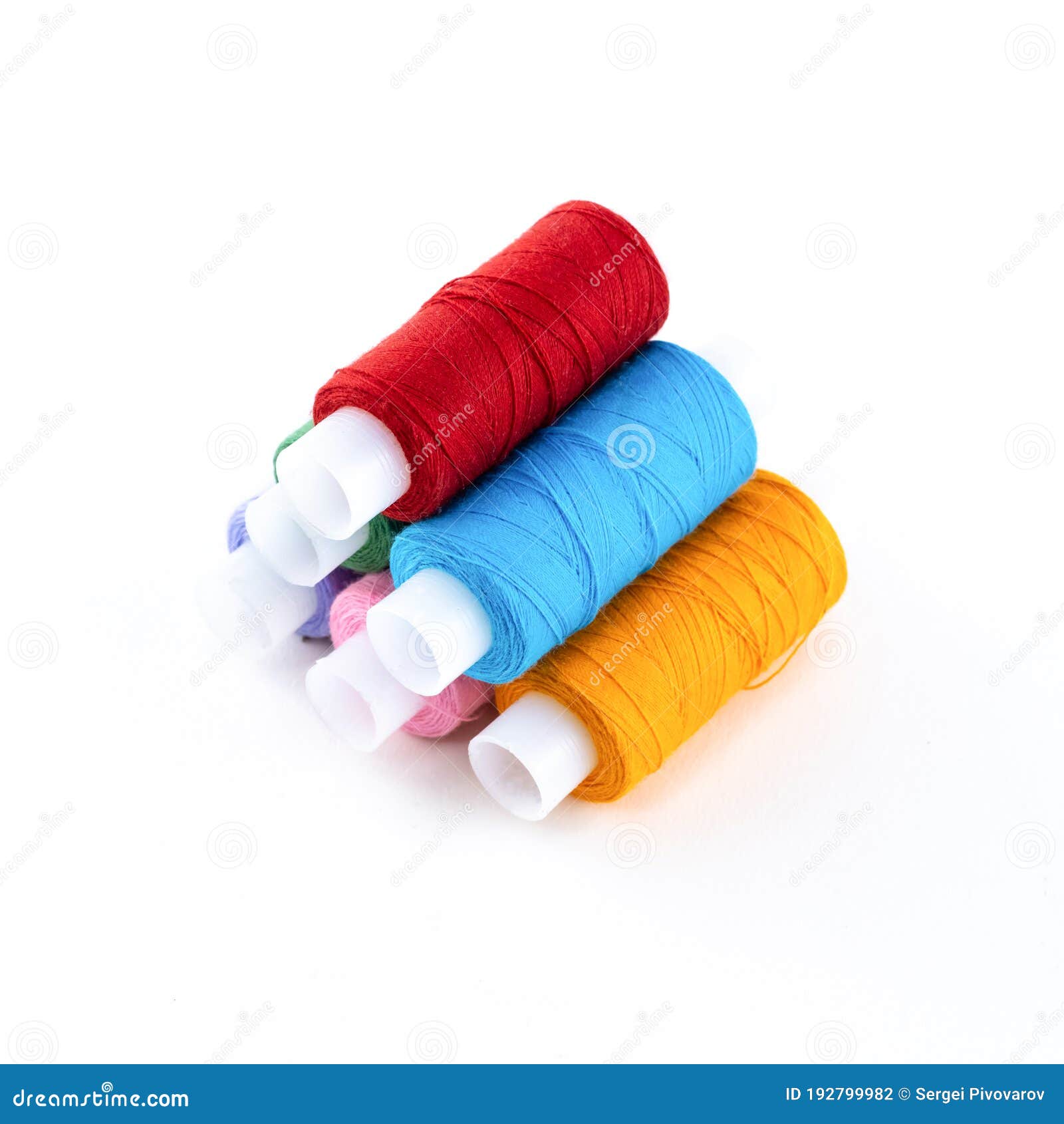 Stack of Spools of Thread Bright Red, Blue and Orange on a White ...
