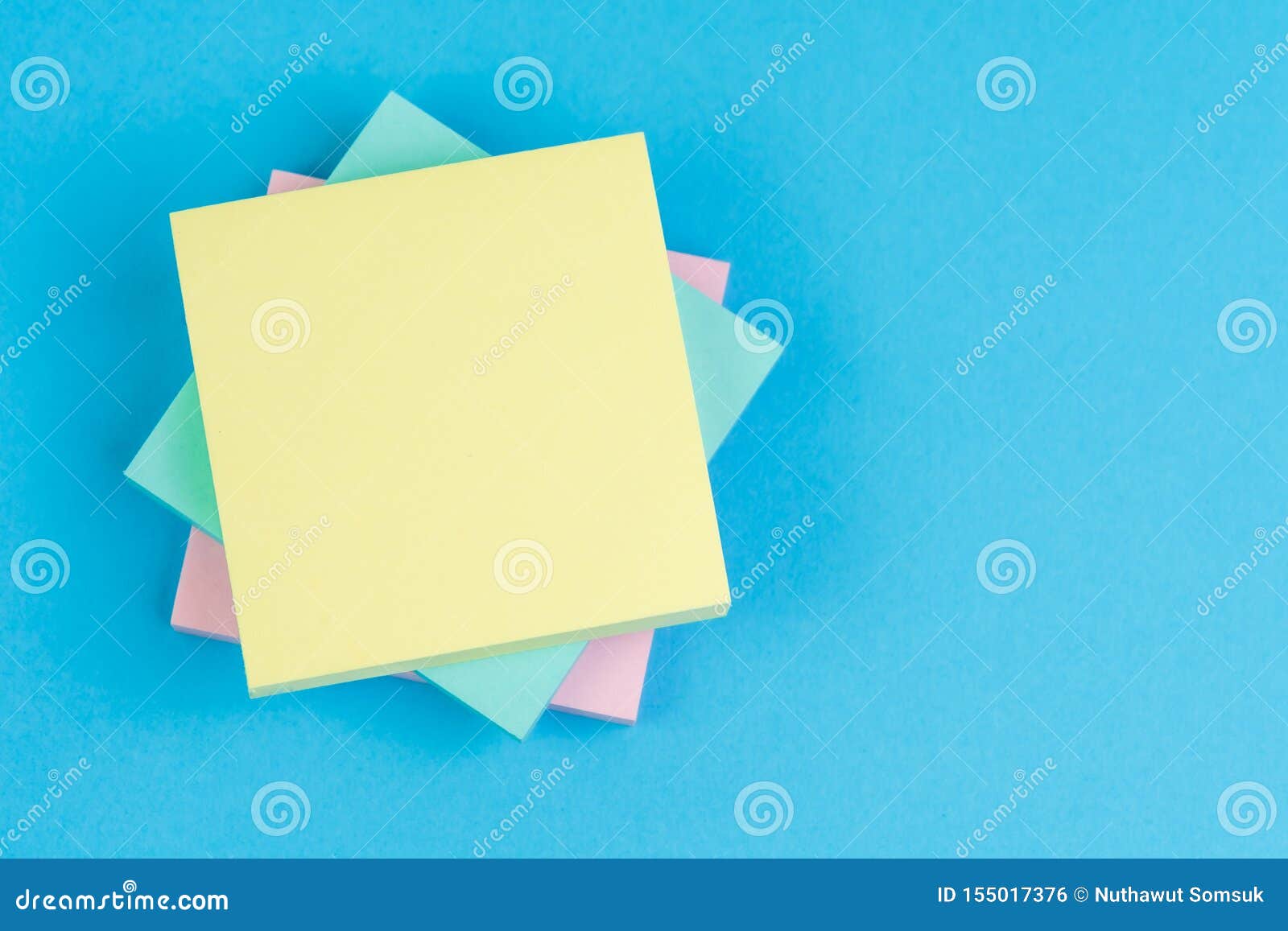 Stack of Sticky Notes on Solid Blue Background with Pink, Blue and ...