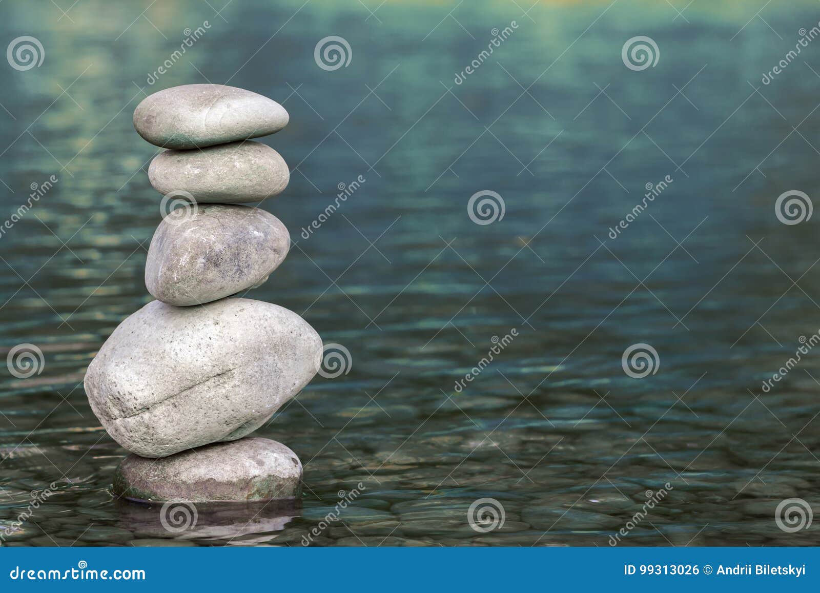 Stack of Stones Balancing on Top in Blue Water of the River Stock Photo ...