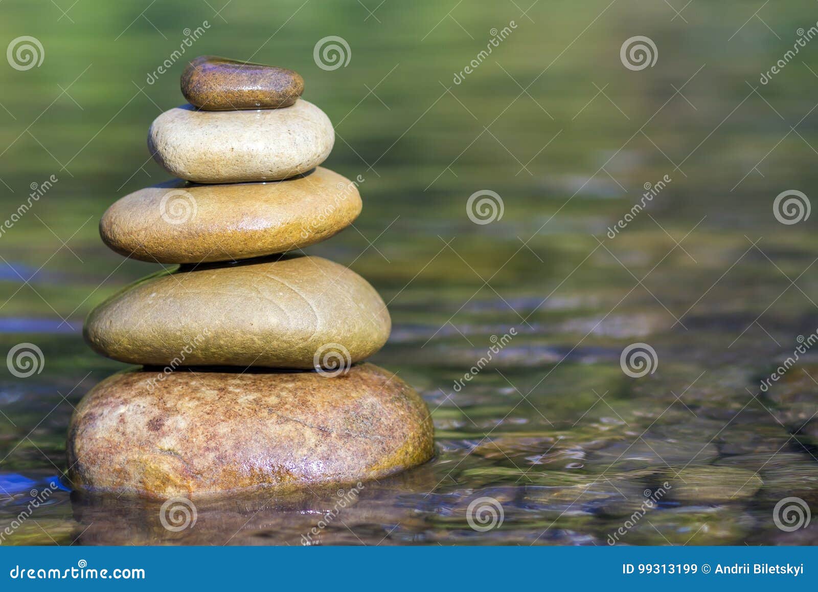 Stack of Stones Balancing on Top in Green Water of the River Stock ...