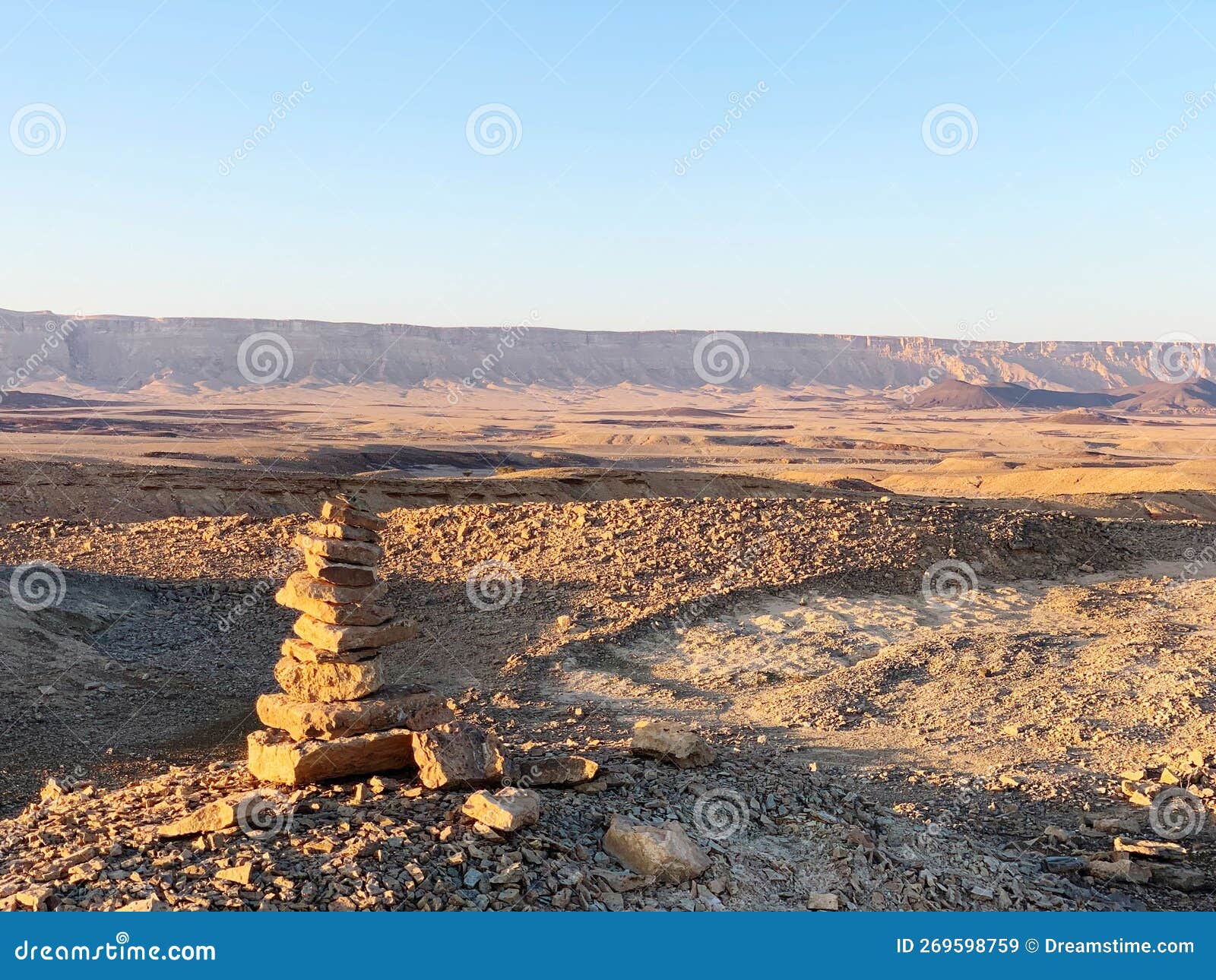 Stack of Stones in a Desert Landscape and Cliff in the Background on a ...