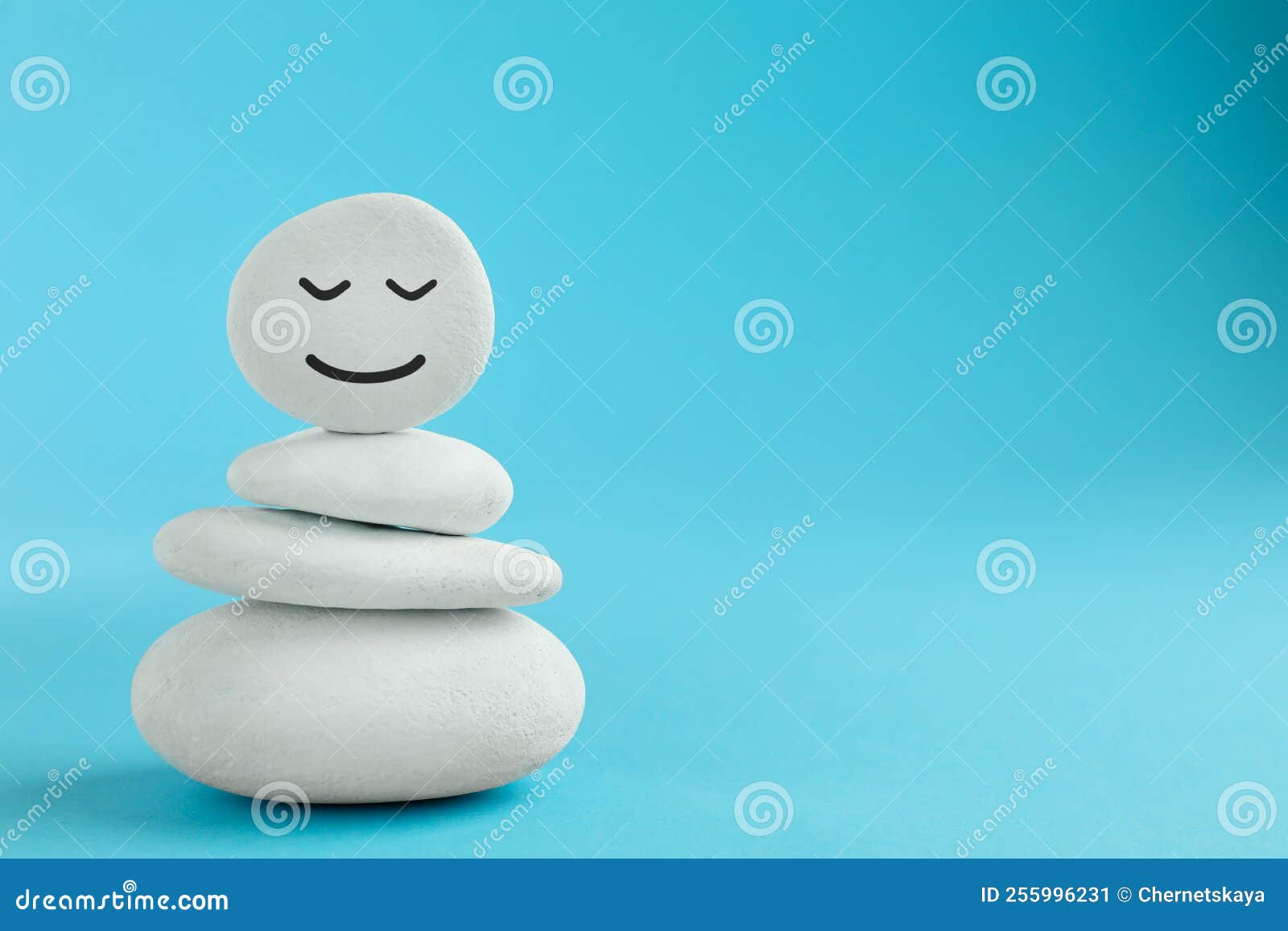 Stack of Stones with Drawn Happy Face on Light Blue Background, Space ...