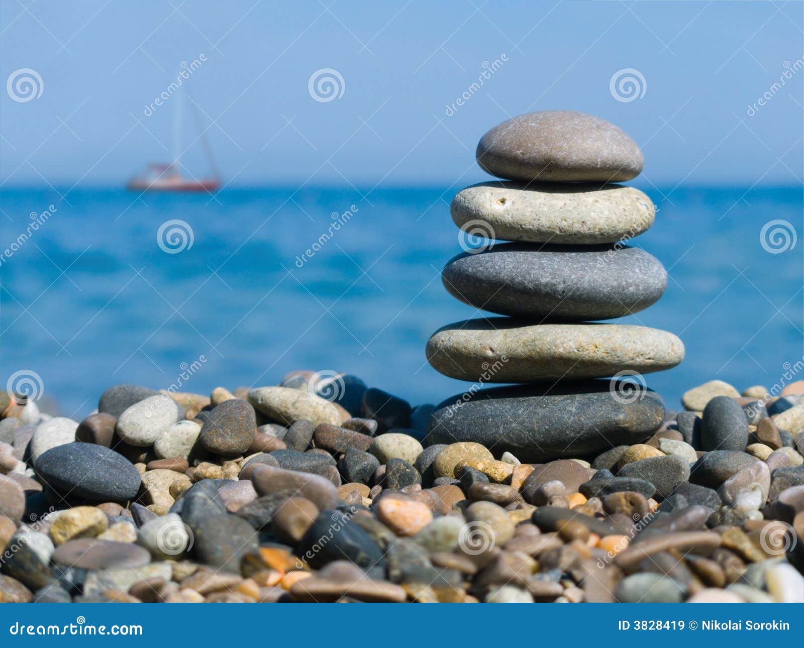 Stack of stones and yacht stock image. Image of beach - 3828419