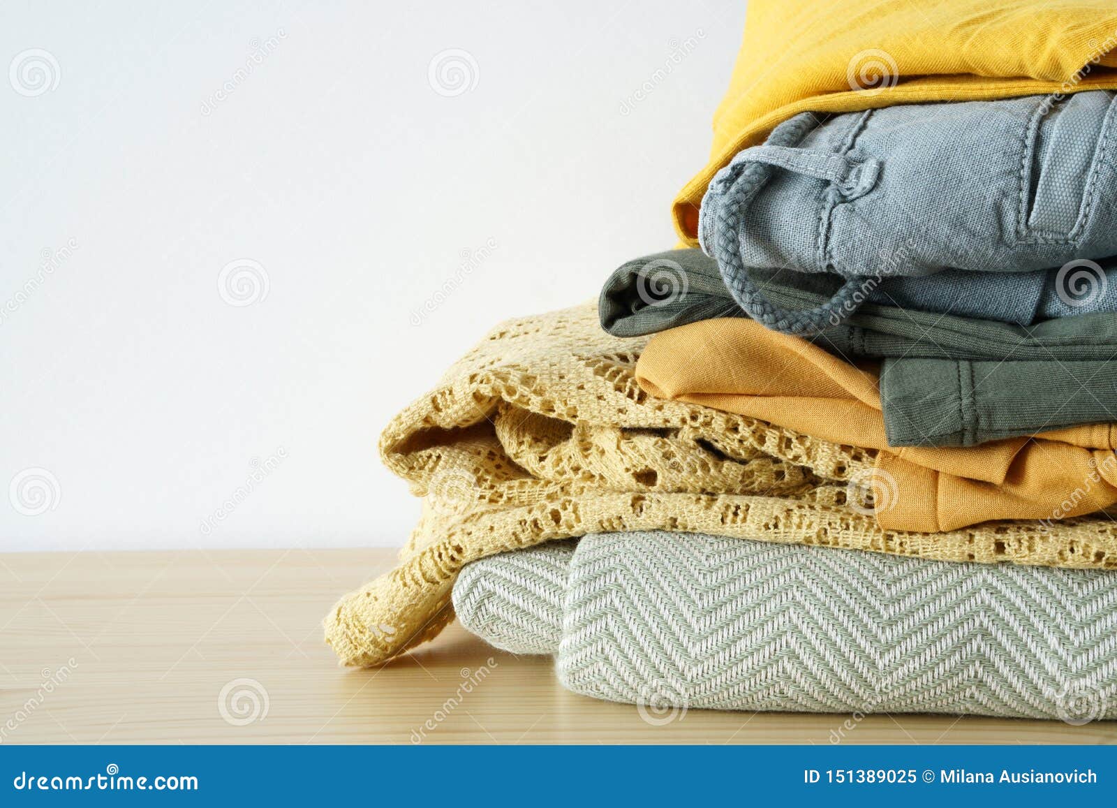 Stack of Summer Clothes on Wooden Surface and White Background Stock ...