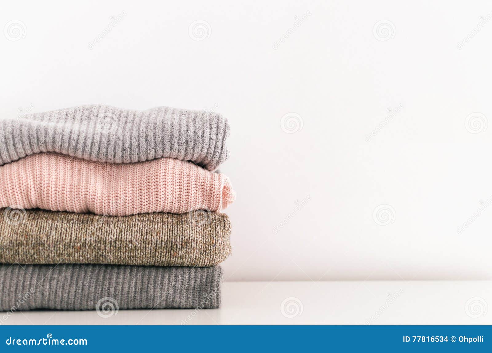 Stack of Sweaters on White Background. Copy Space Stock Photo - Image ...
