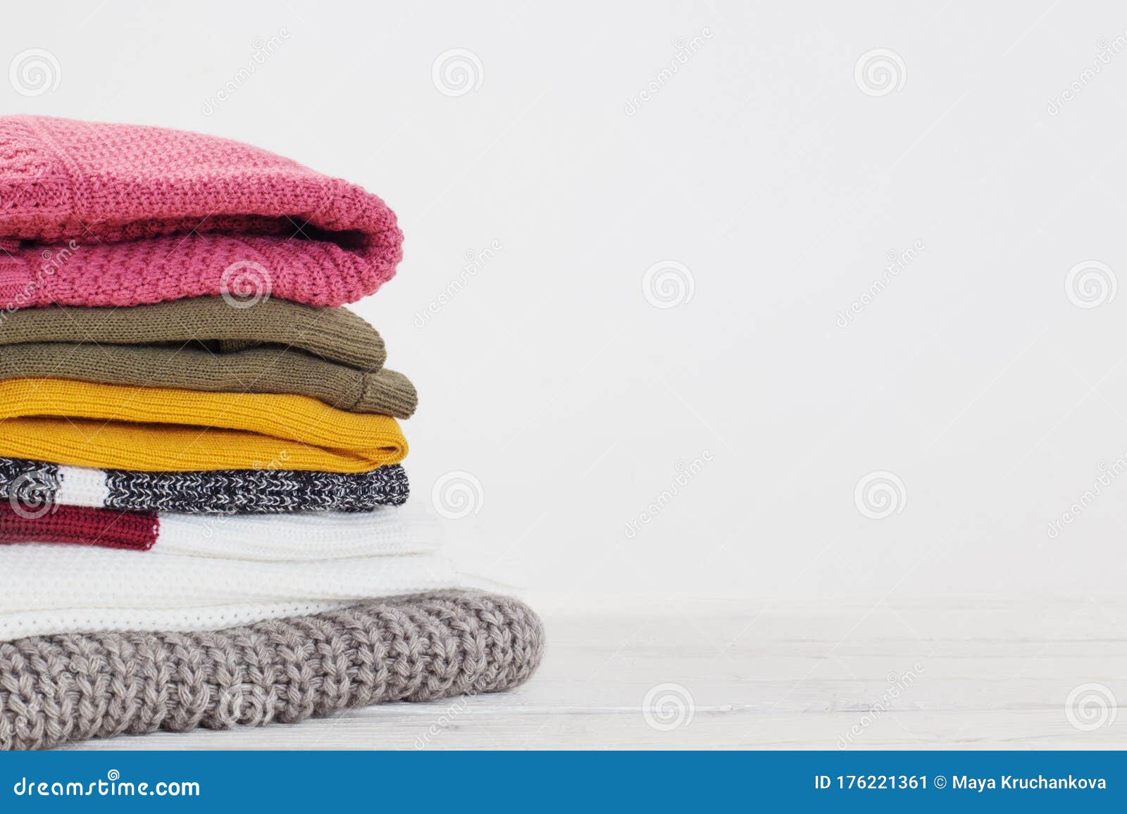 Stack of Sweaters on Wooden Table Stock Image - Image of stack ...