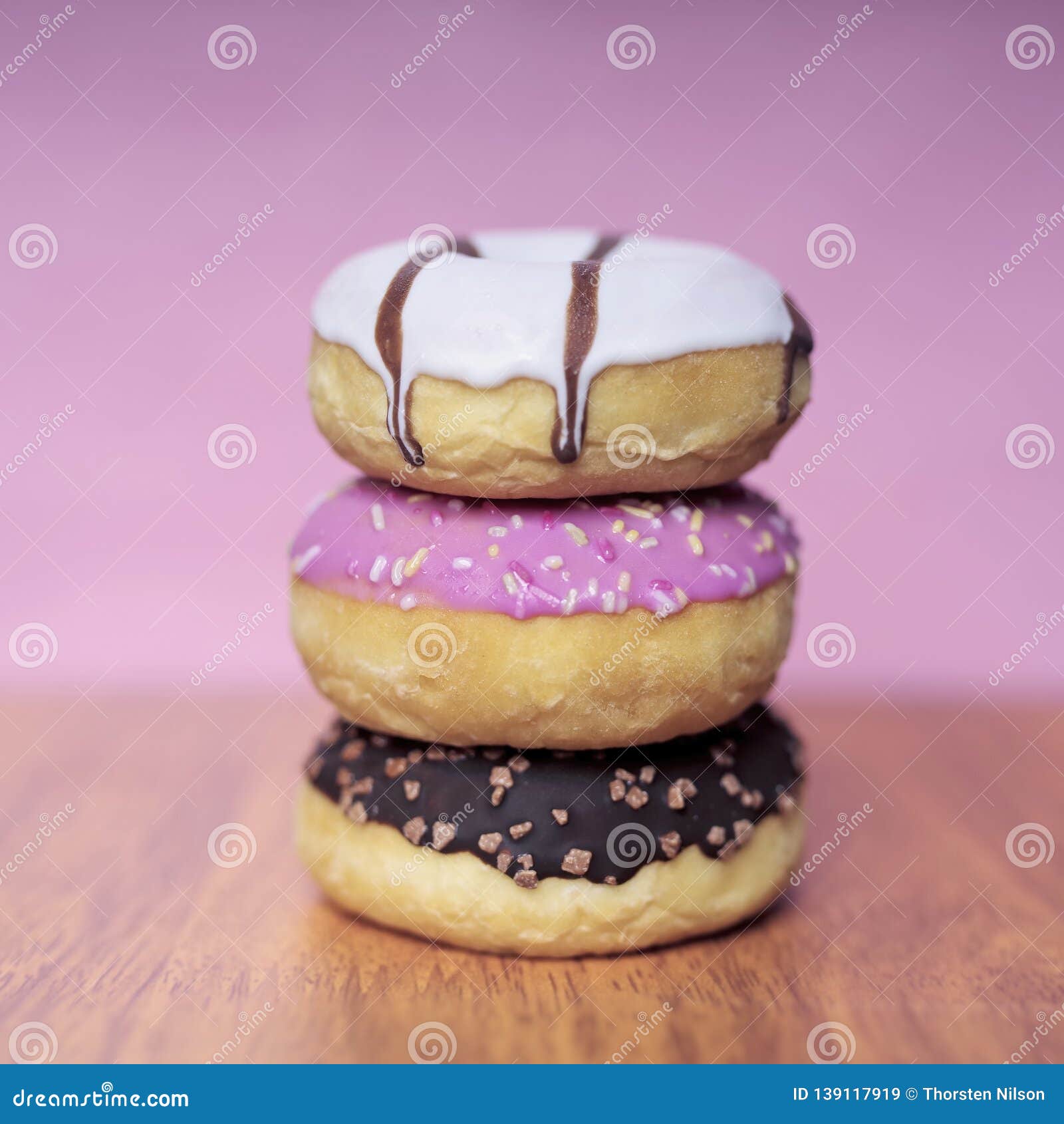 Stack of Sweet Glazed Doughnuts on Pink Background. Stock Image - Image ...