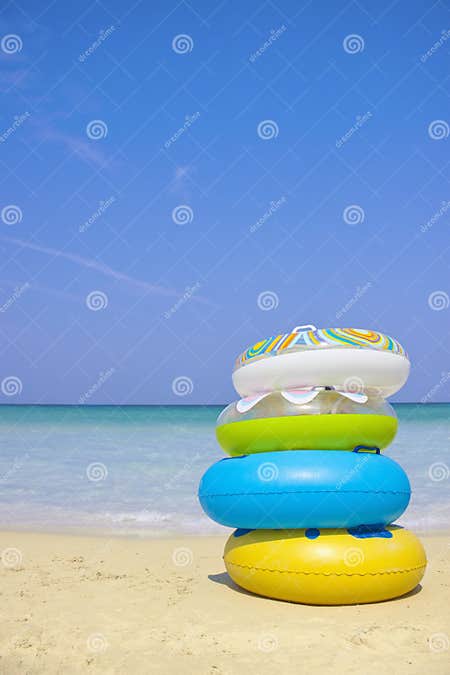 Stack of Swimming Tubes on the Beach Stock Image - Image of leisure ...